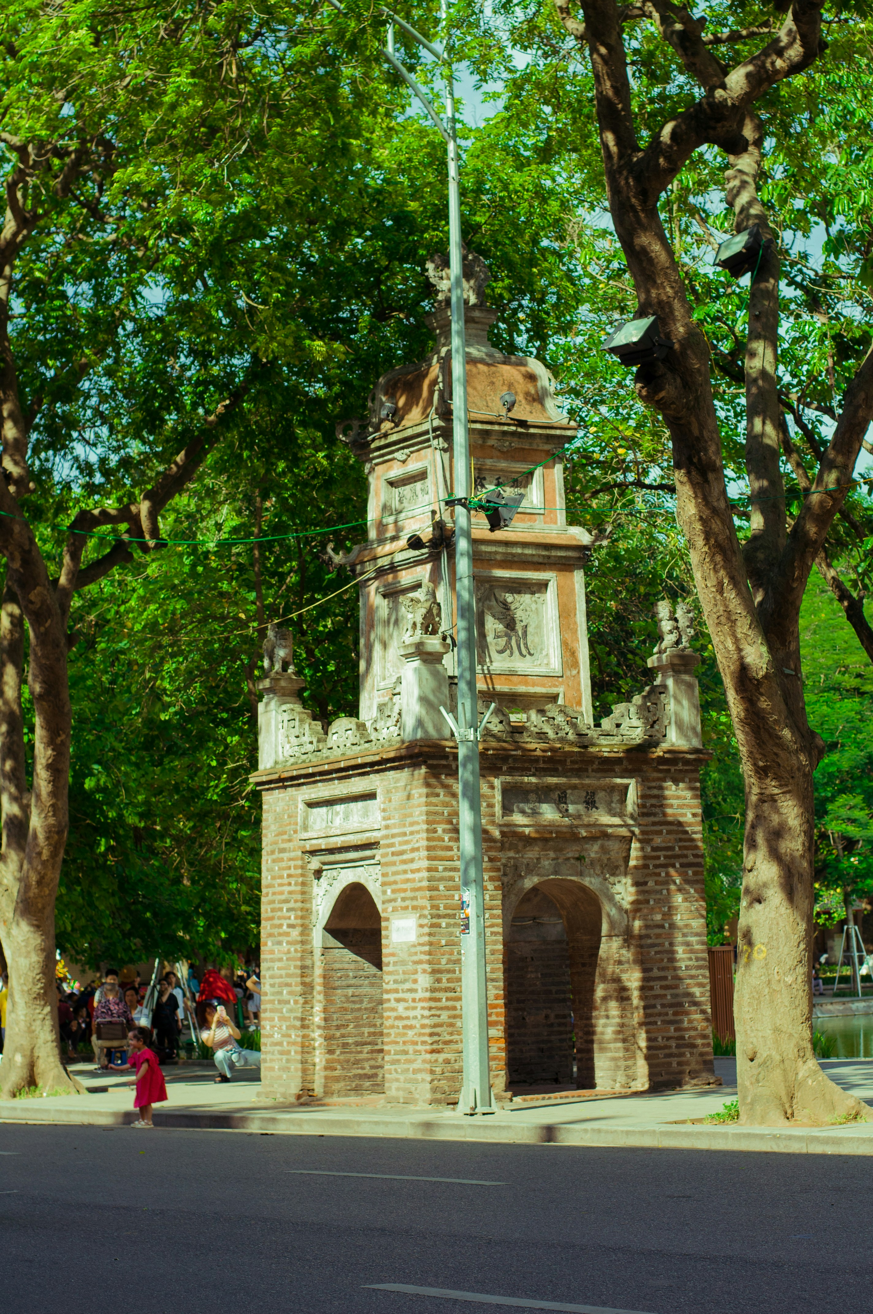 Brick Gateway Monument Framed by Green Canopy in a City Park