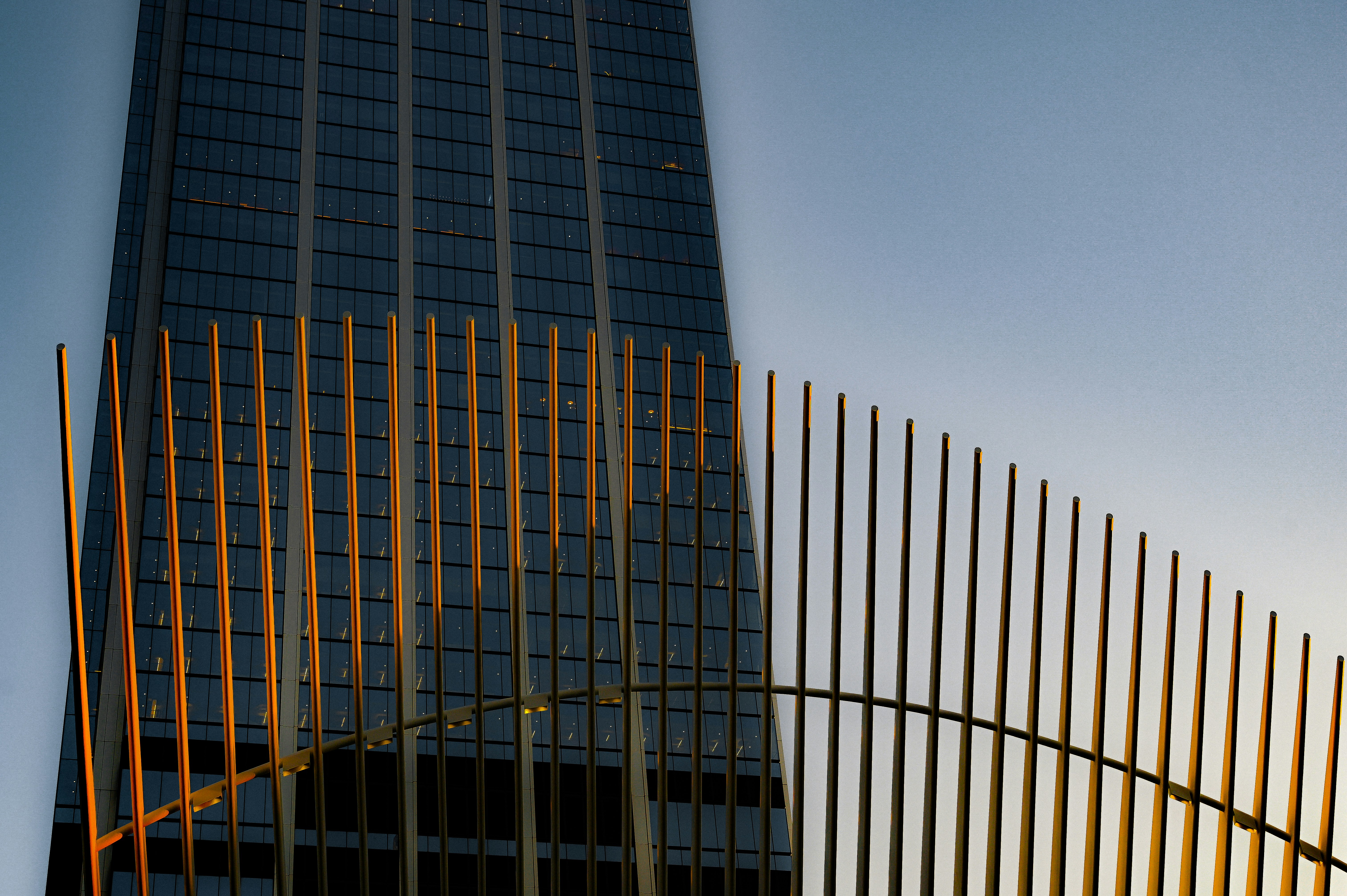 Ember Arches: Curved Orange Rods Framing a Glass Skyline
