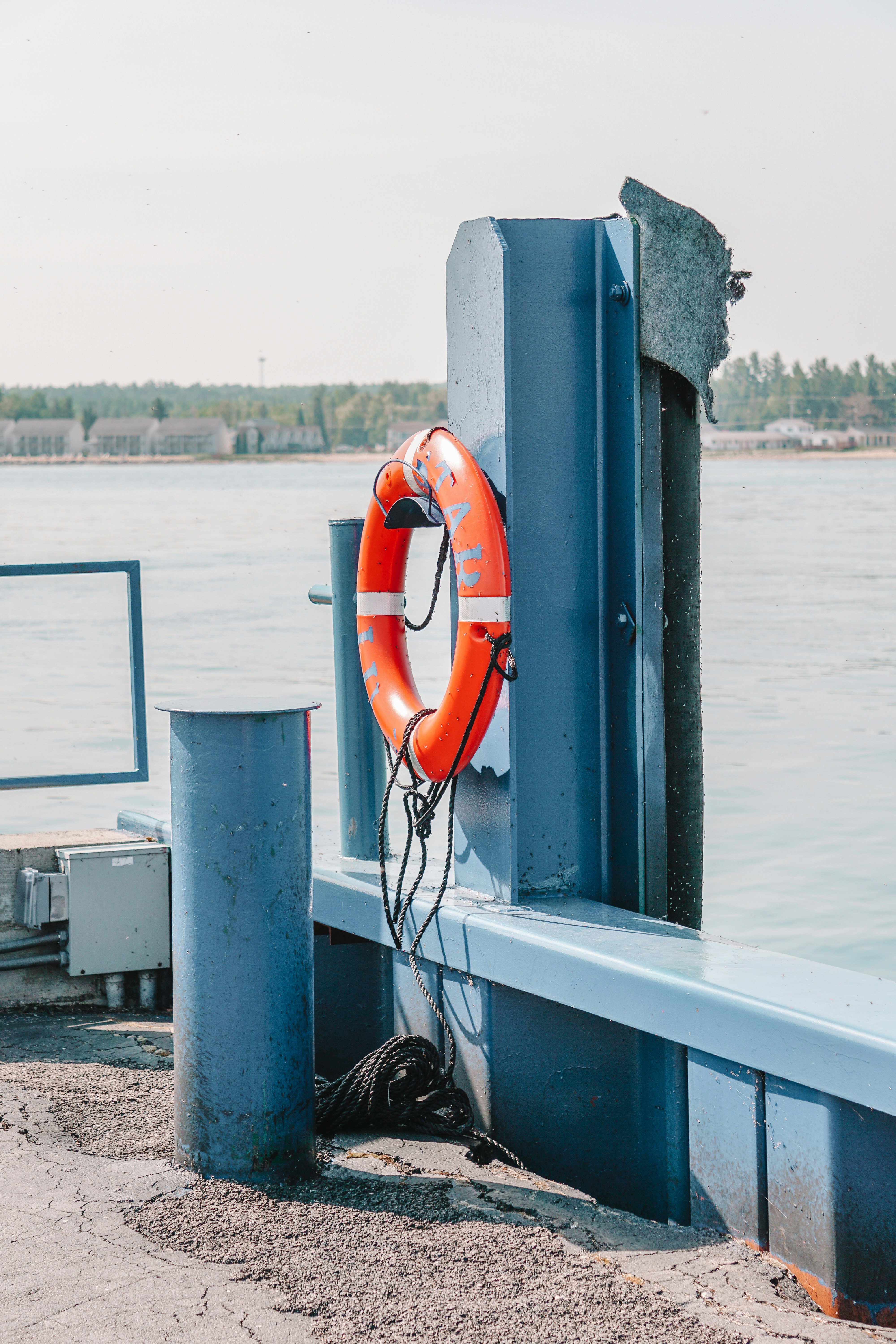 A life preserver on a dock next to the water photo – Free Mackinaw city ...