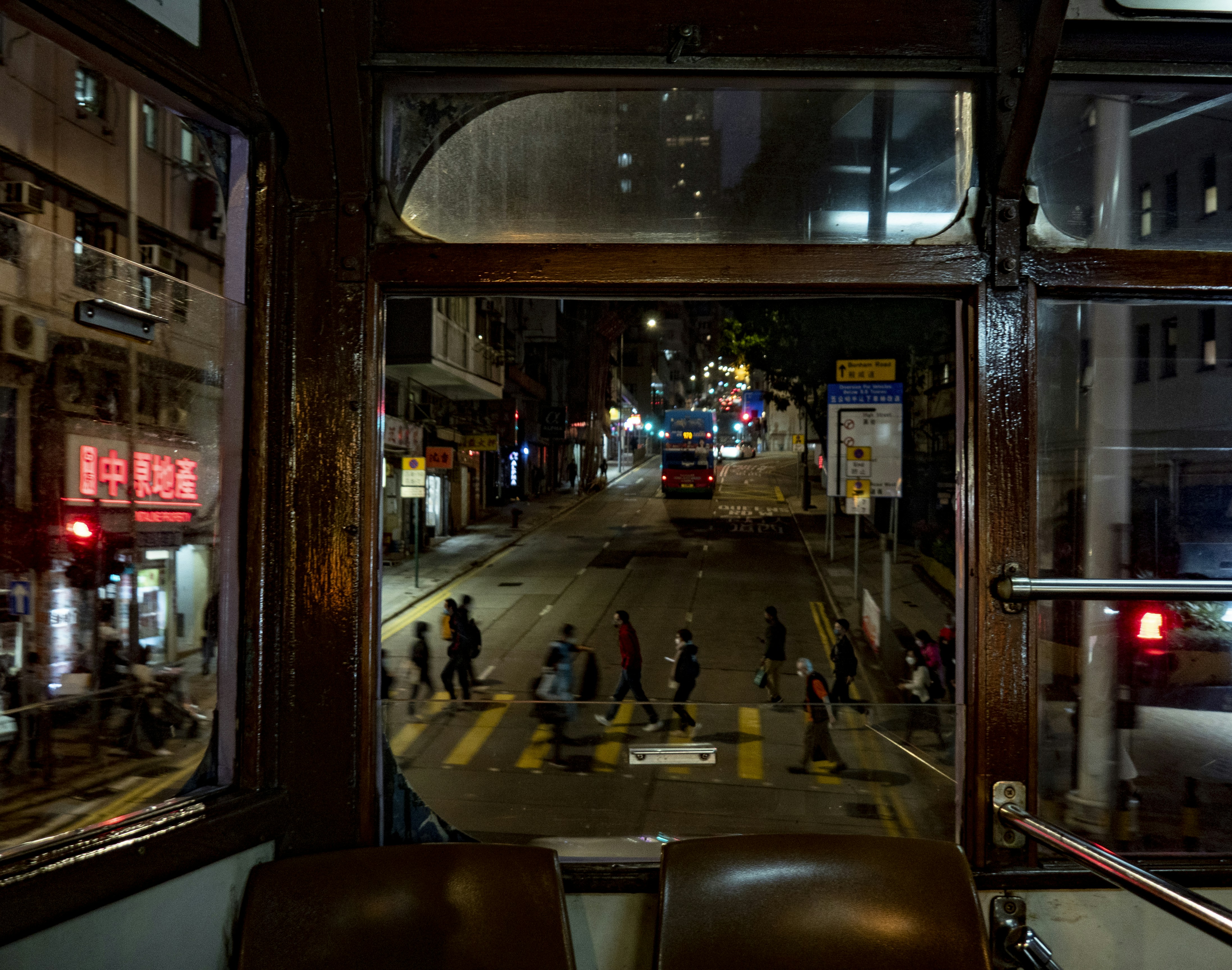 Neon Crosswalk from a Tram Window: Nightlife in Motion