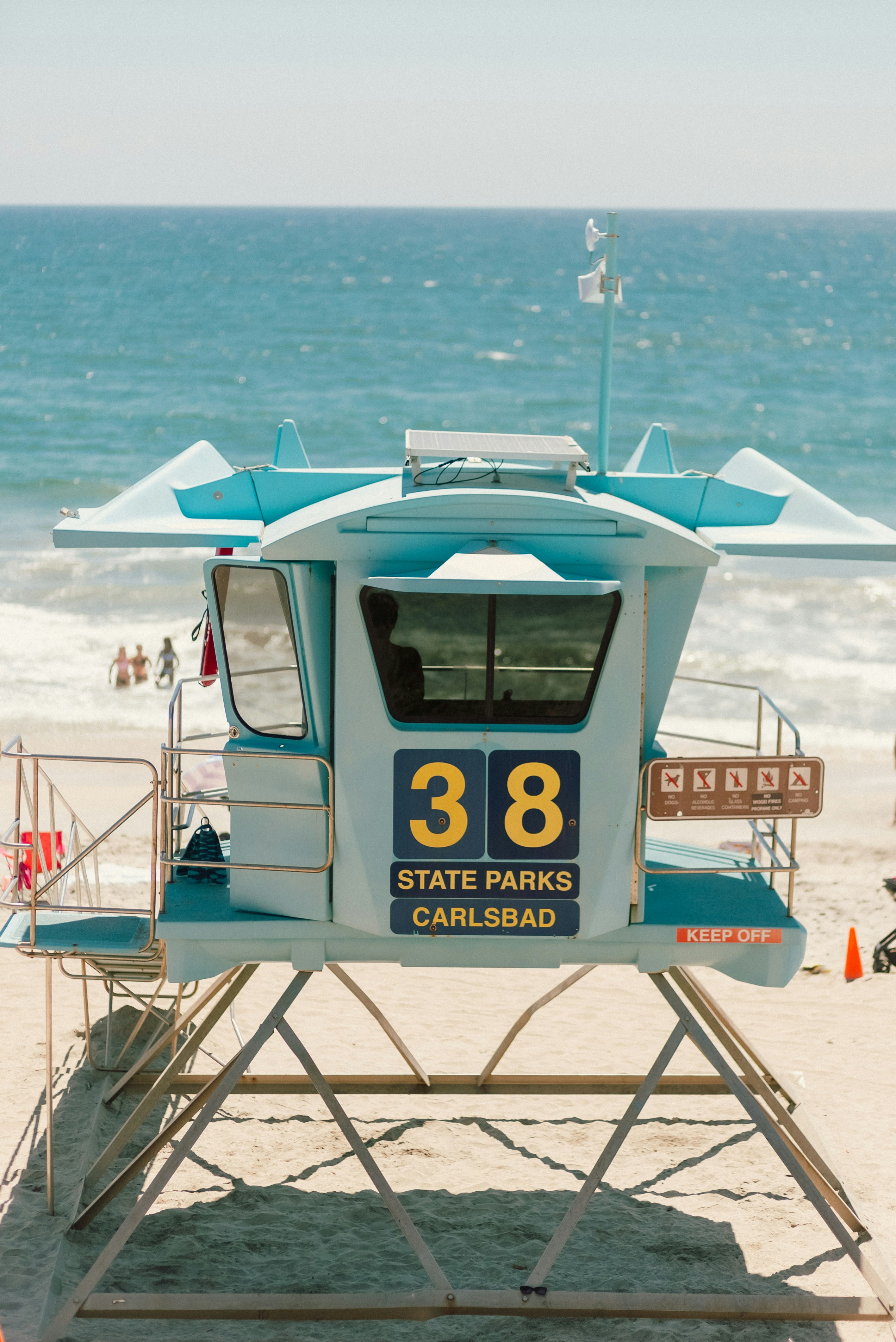 A lifeguard stand on the beach with the ocean in the background photo ...