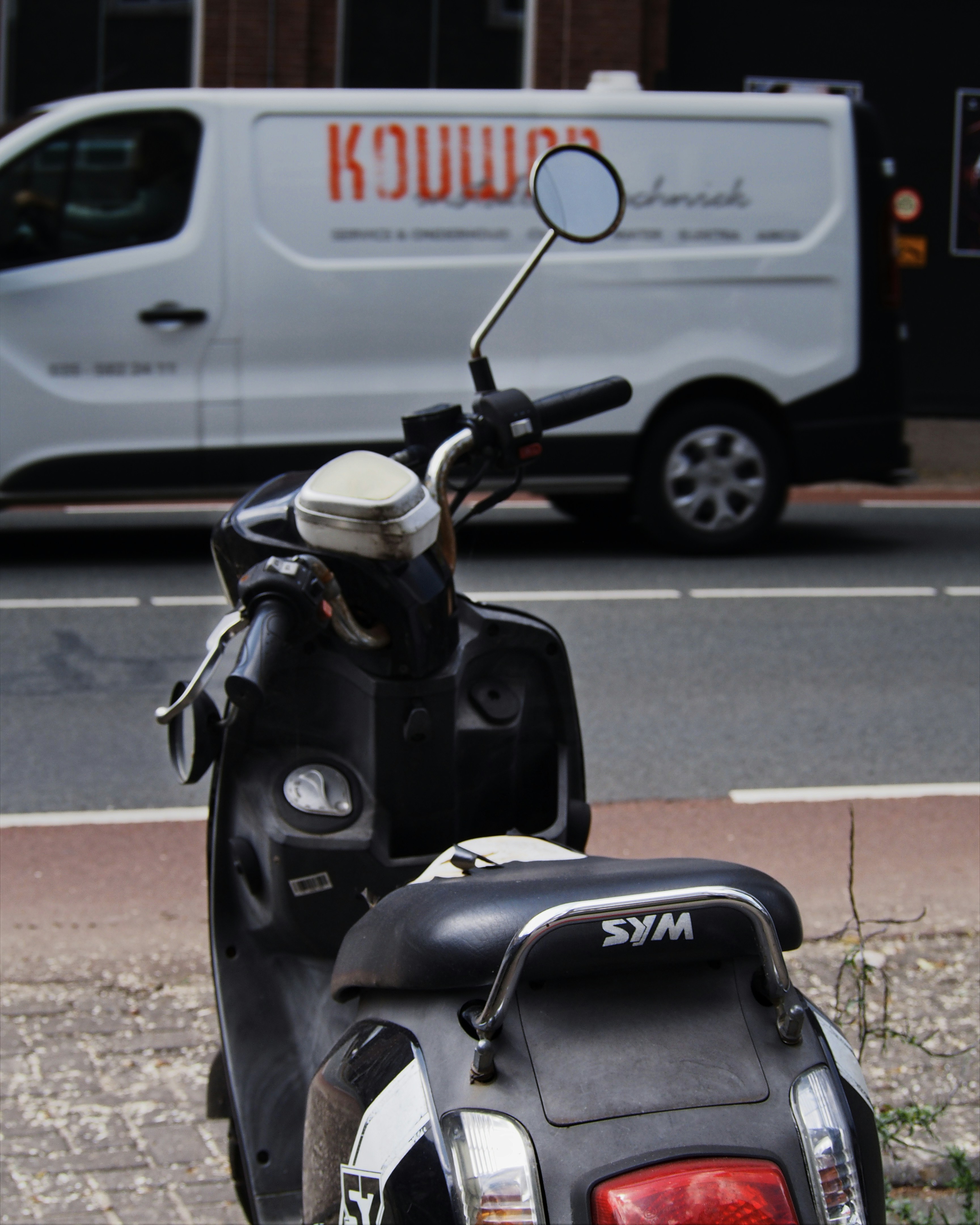 A scooter parked on the side of the road photo – Free Moped Image on ...