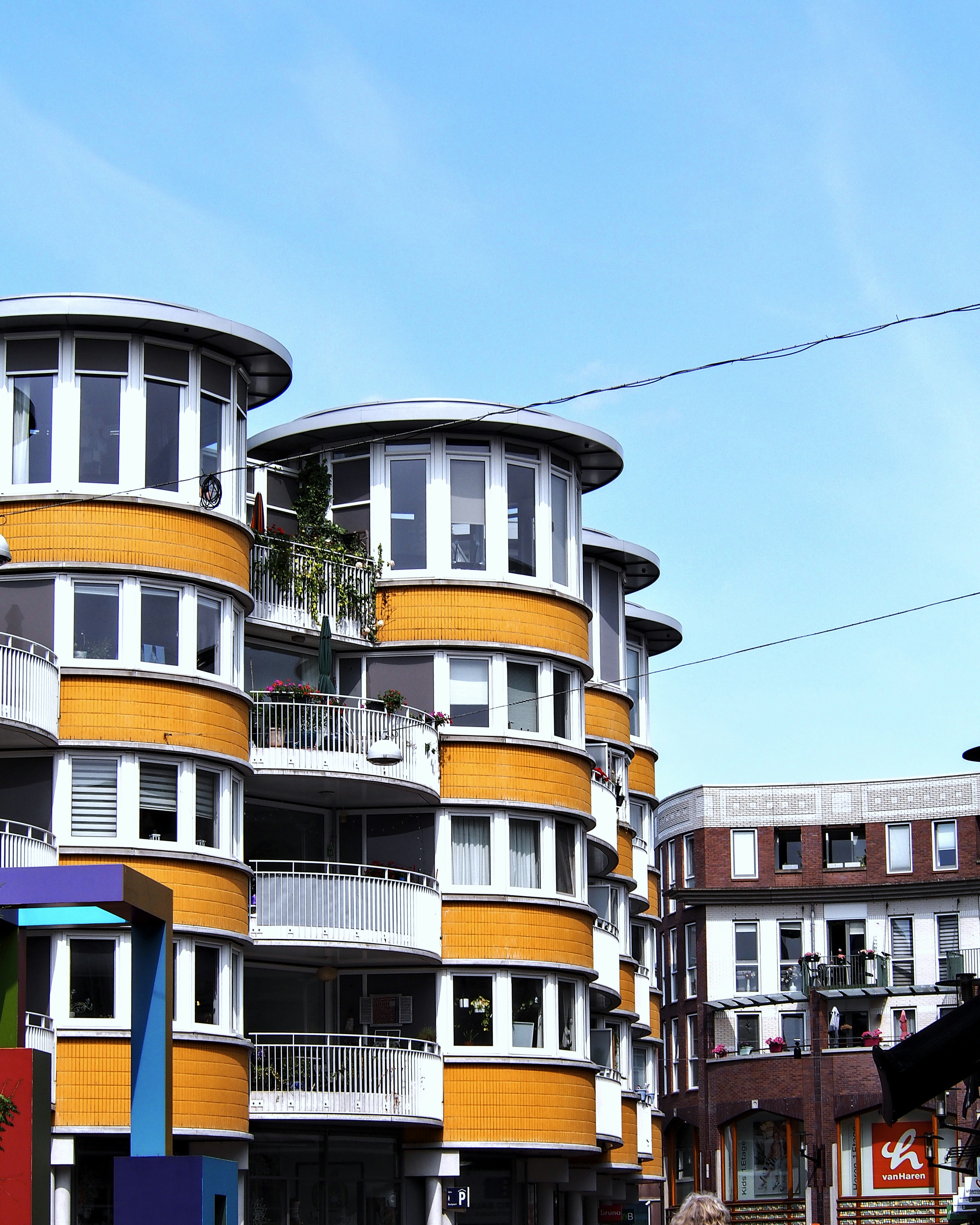 Orange Cylinders: A Vertical Chorus of Curved Balconies