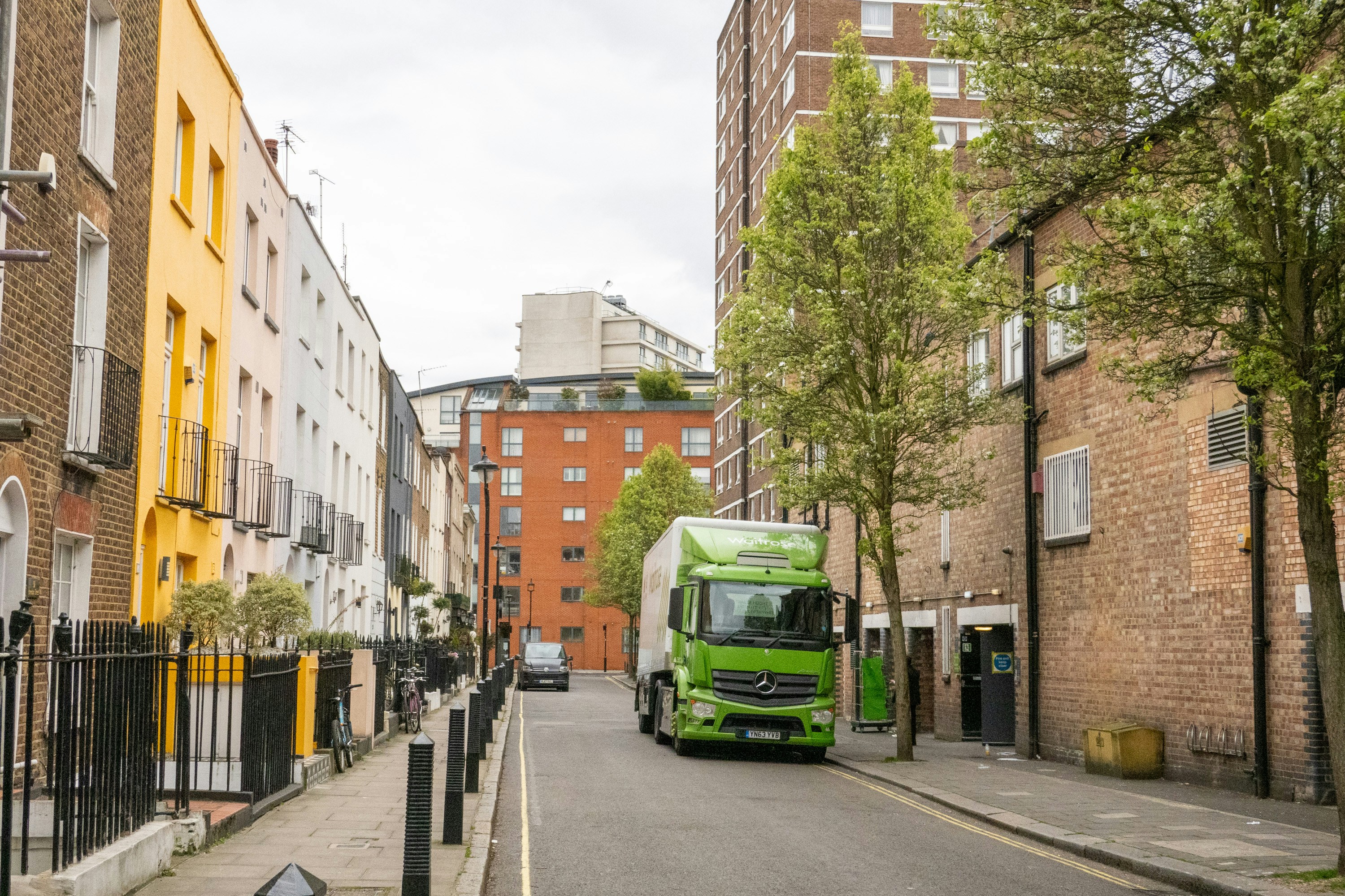 Green Mercedes Truck Anchors a Quiet Urban Street