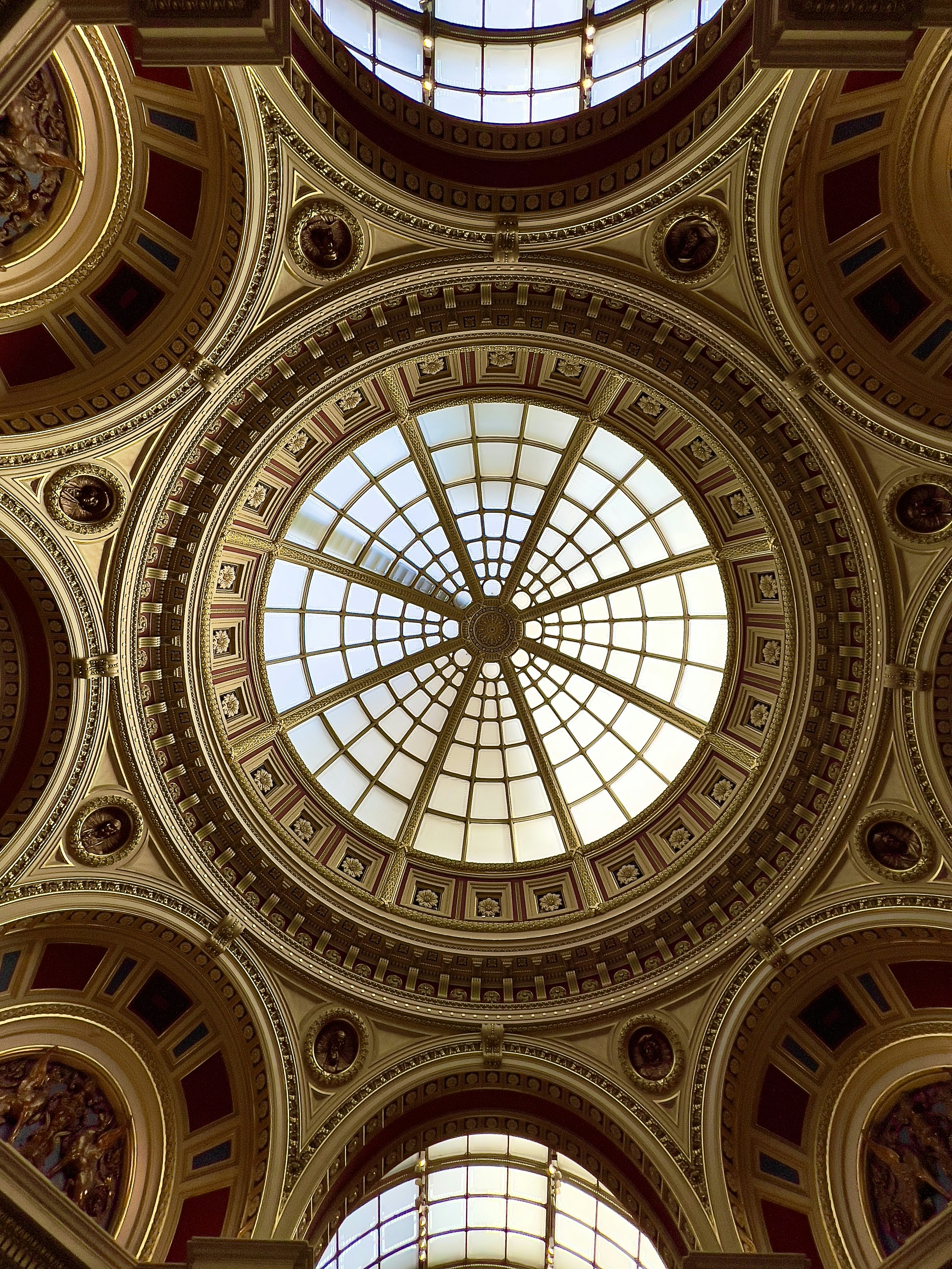 The ceiling of a building with a circular glass window photo – Free ...