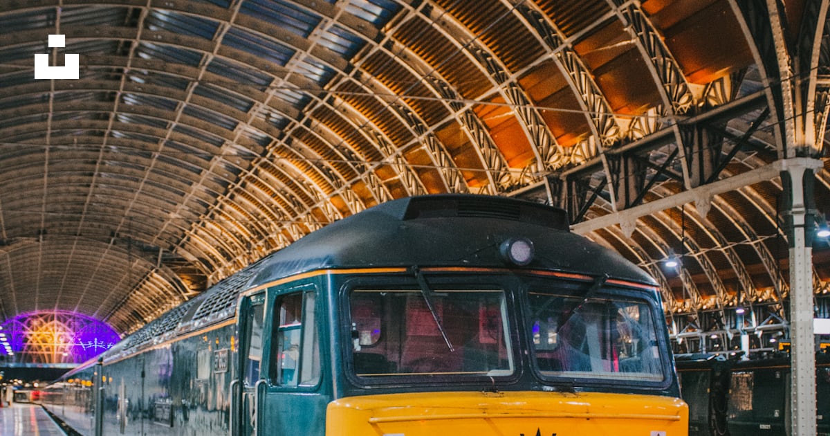 駅に停車する黄色と緑の列車の写真 Unsplashの鉄道駅の無料画像