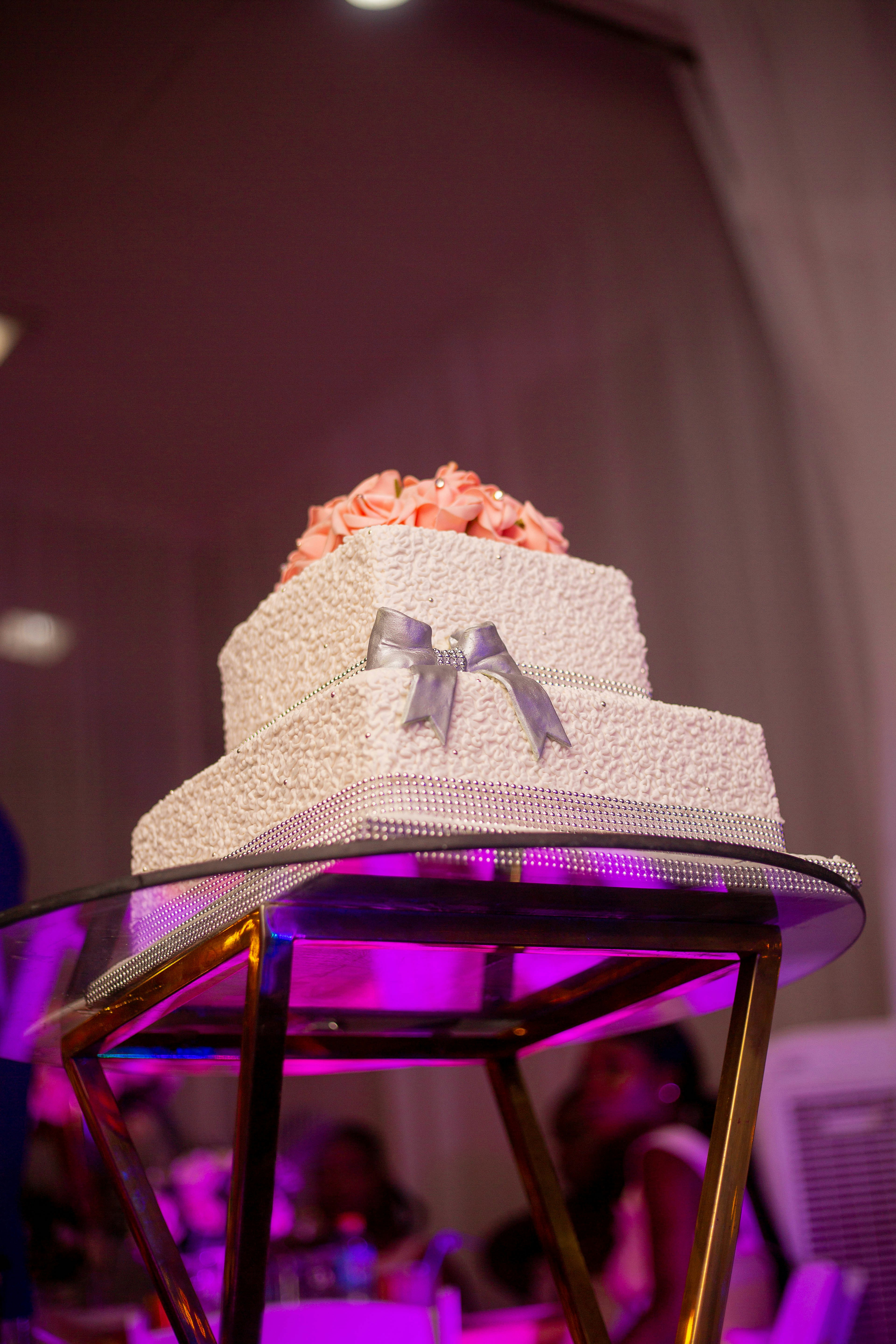 Pearl-Dusted Tiered Cake Under Magenta Glow