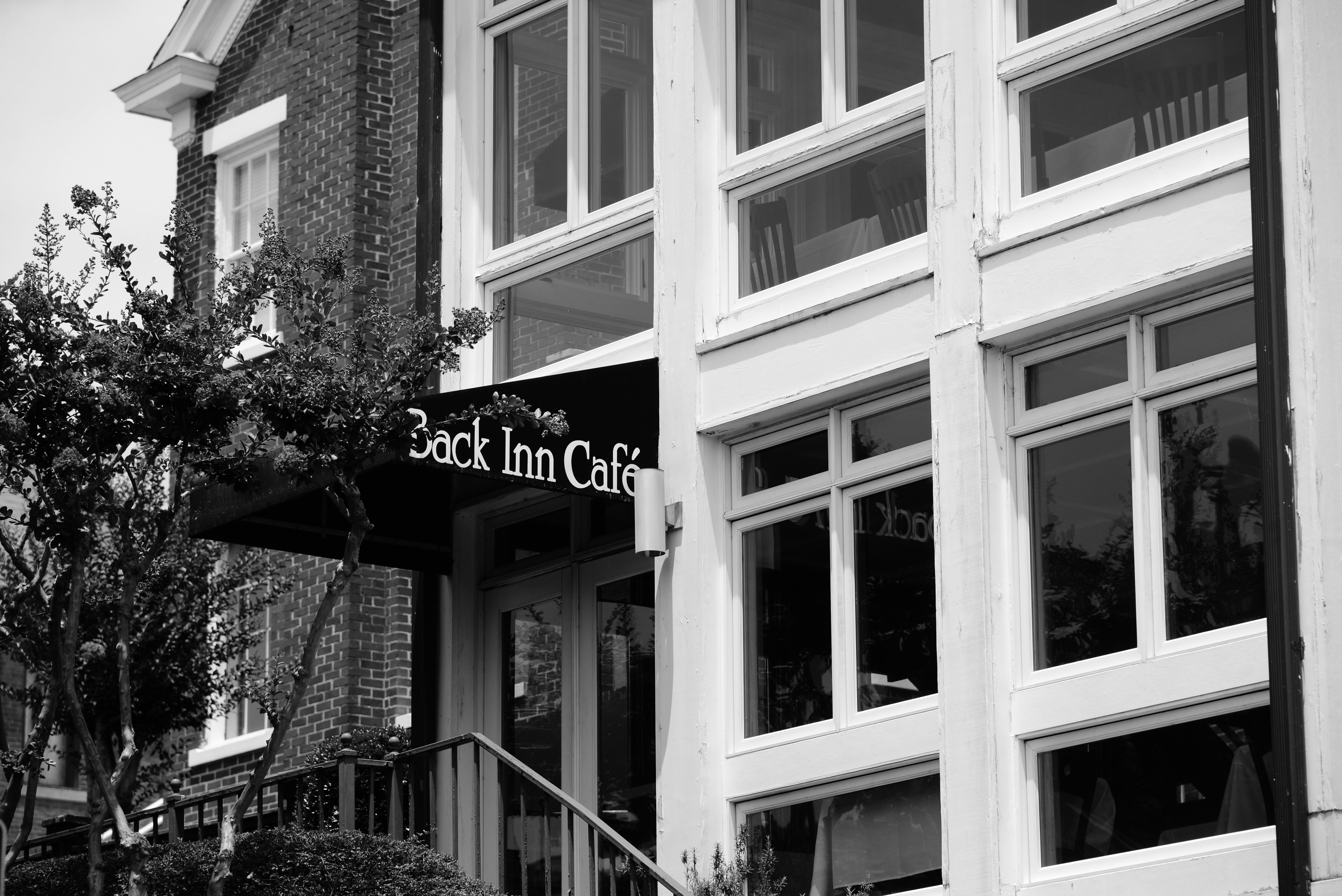 A black and white photo of a building photo – Free Back inn café Image ...