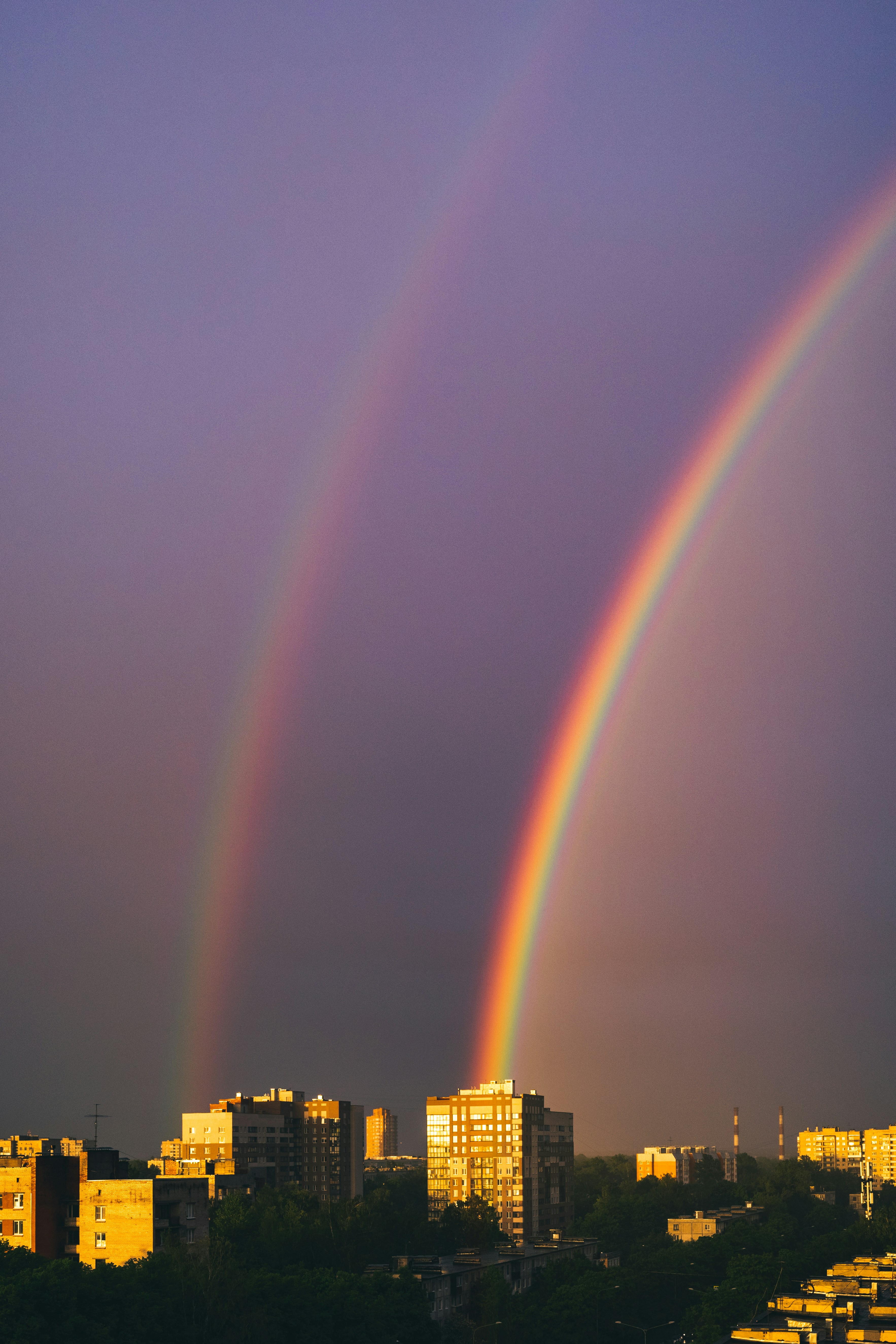 Dusk's Double Arc Over a Rooftop Skyline