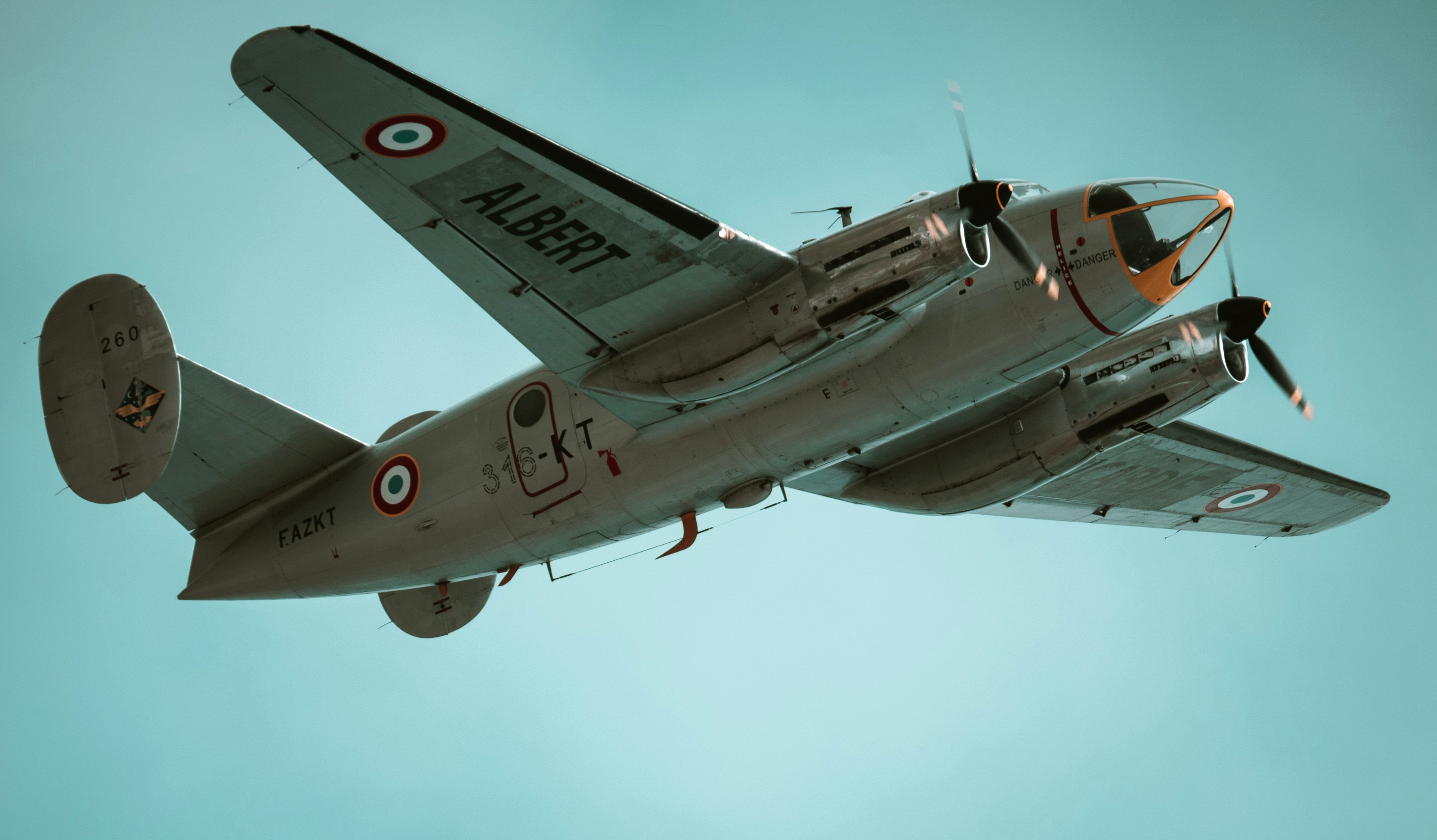 Midflight Mirage: WWII-era bomber slicing through a cyan sky