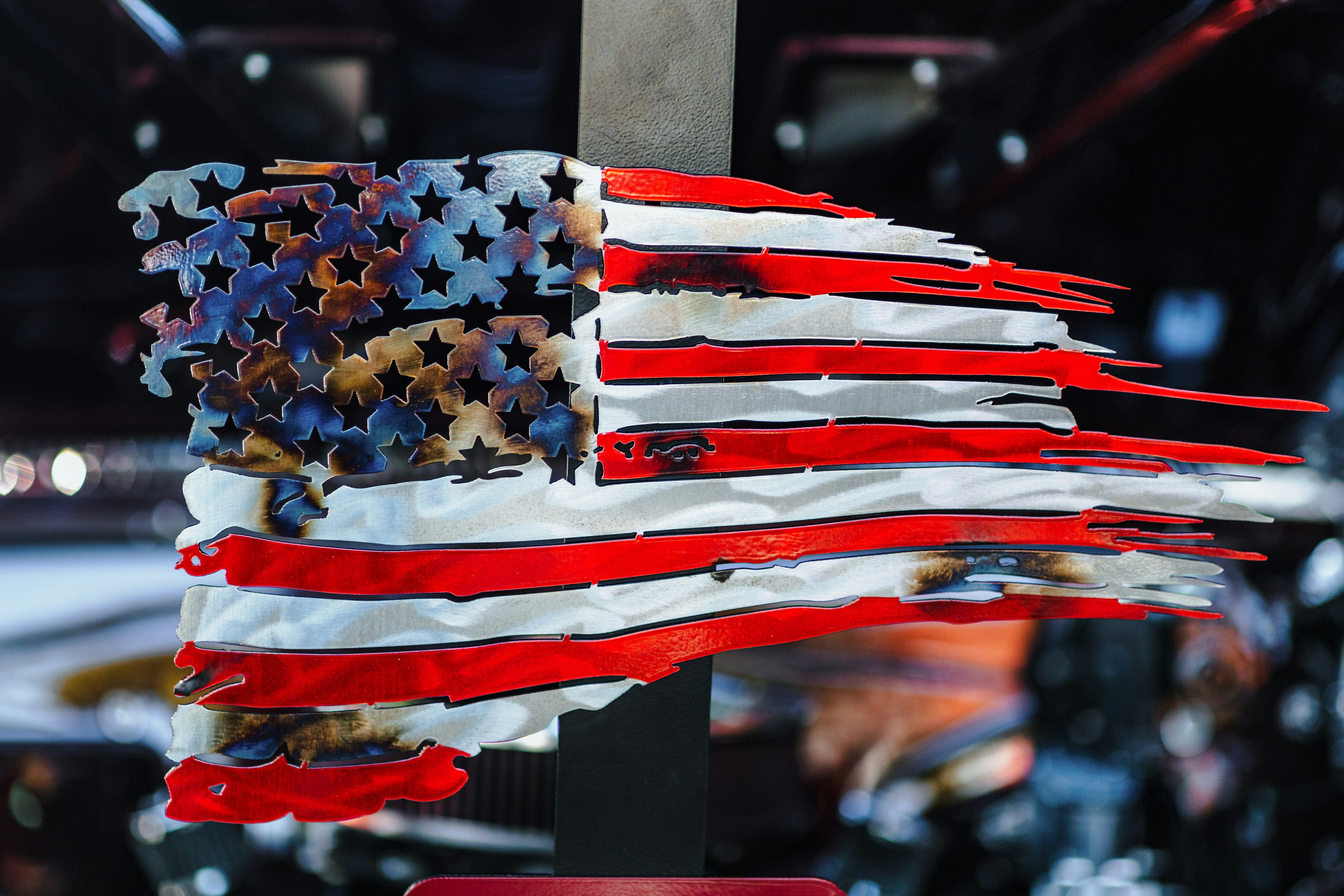 Frayed Stars and Stripes on a Weathered Pole