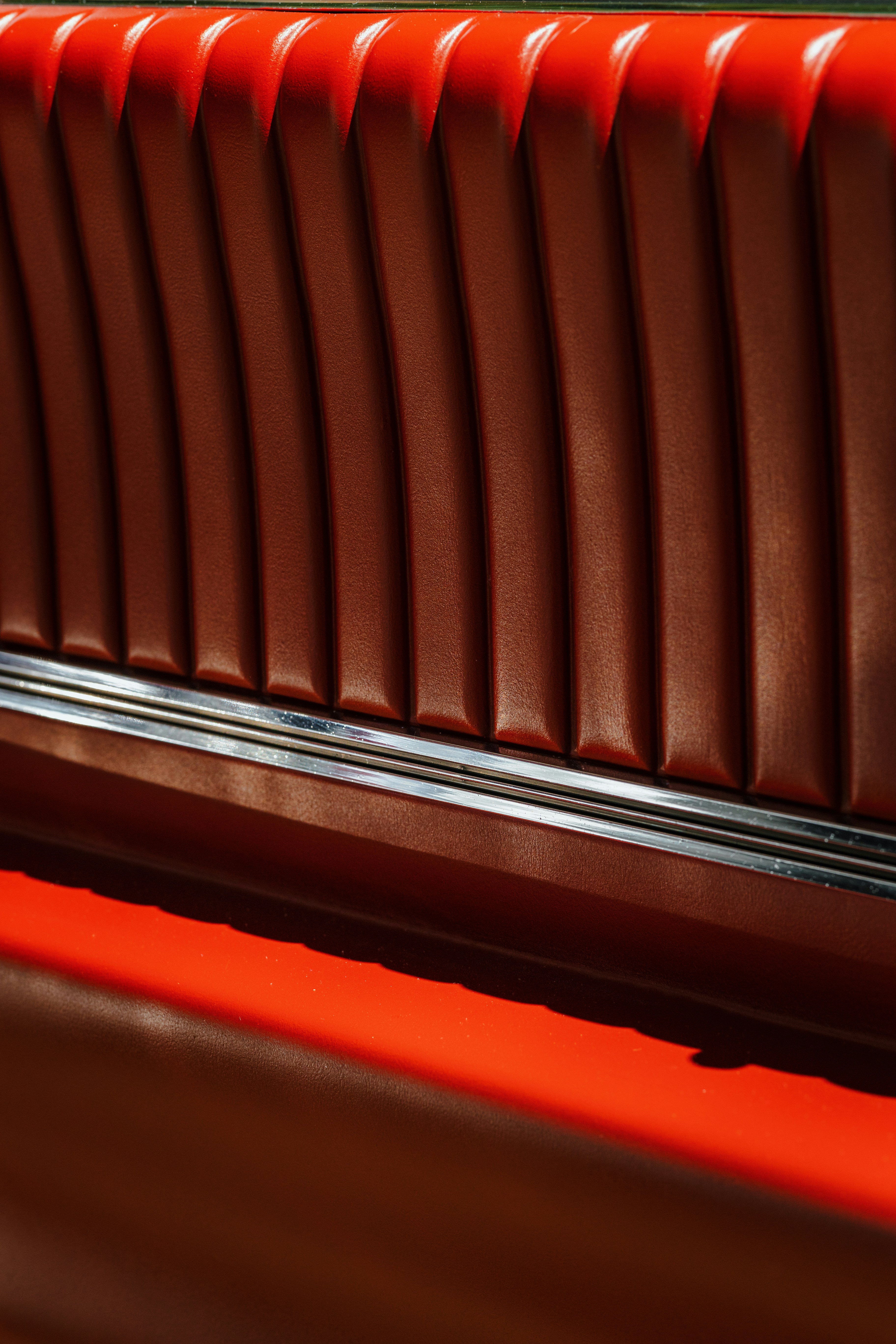 Scarlet Pleats and Chrome: A Close-Up of Classic Car Interior