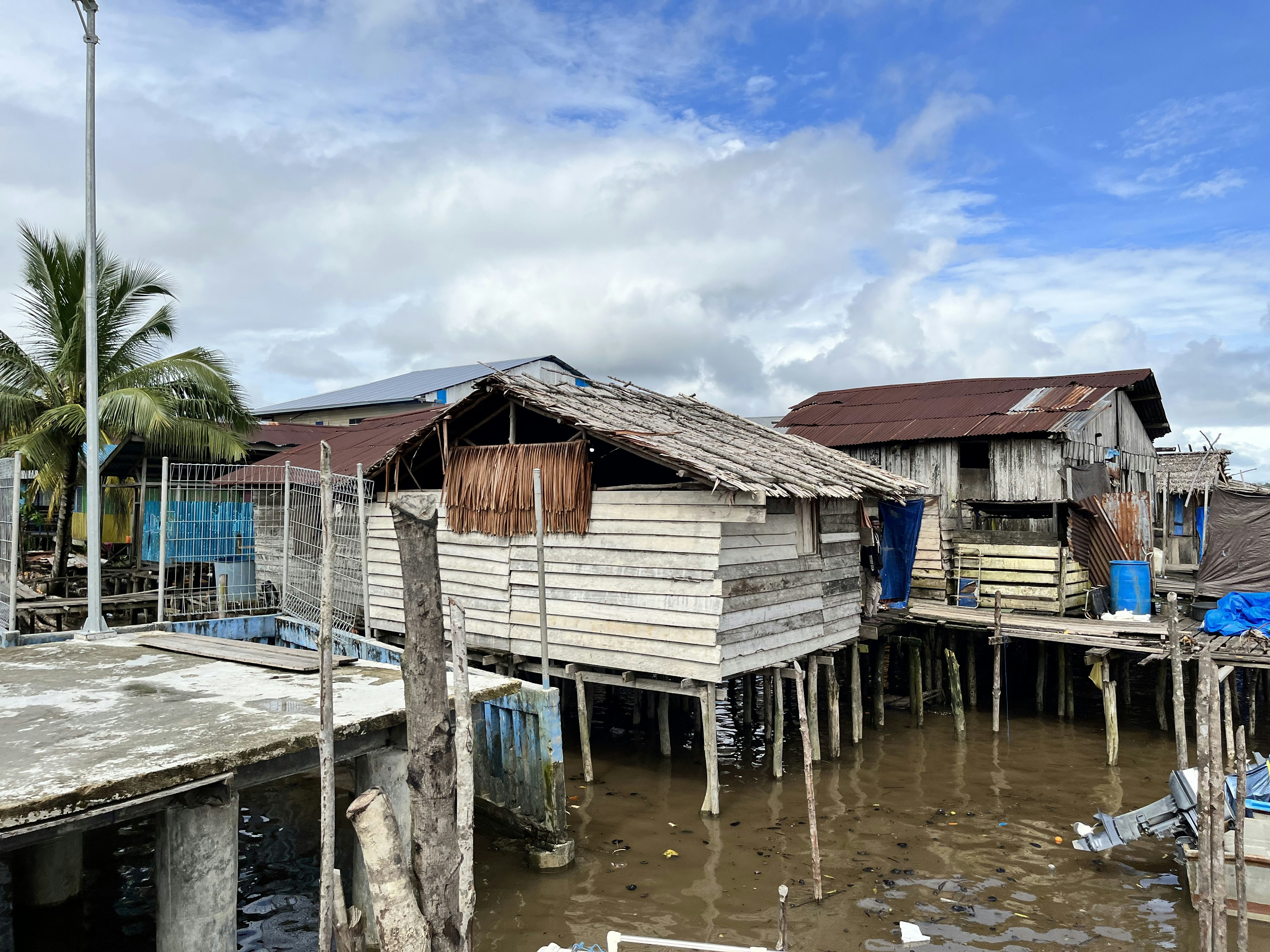 A group of wooden houses sitting on top of a flooded street photo ...