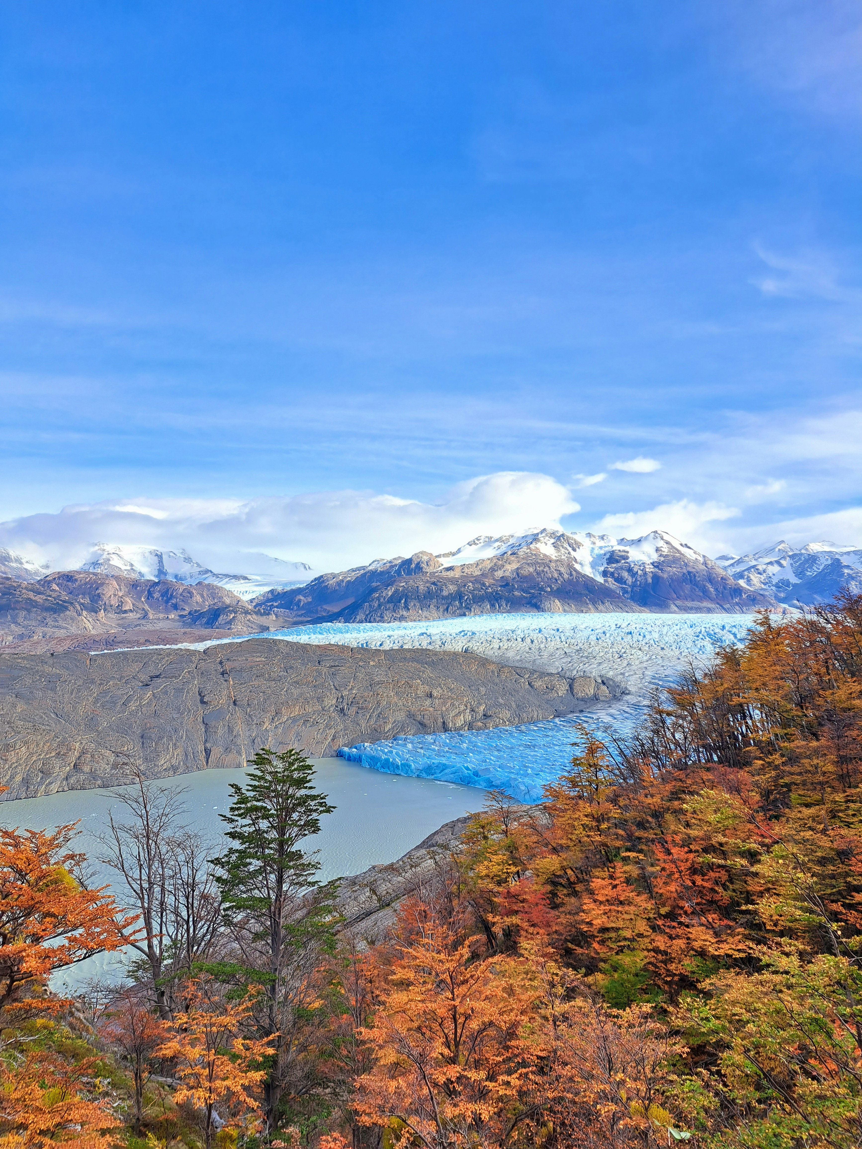 a scenic view of a lake surrounded by mountains