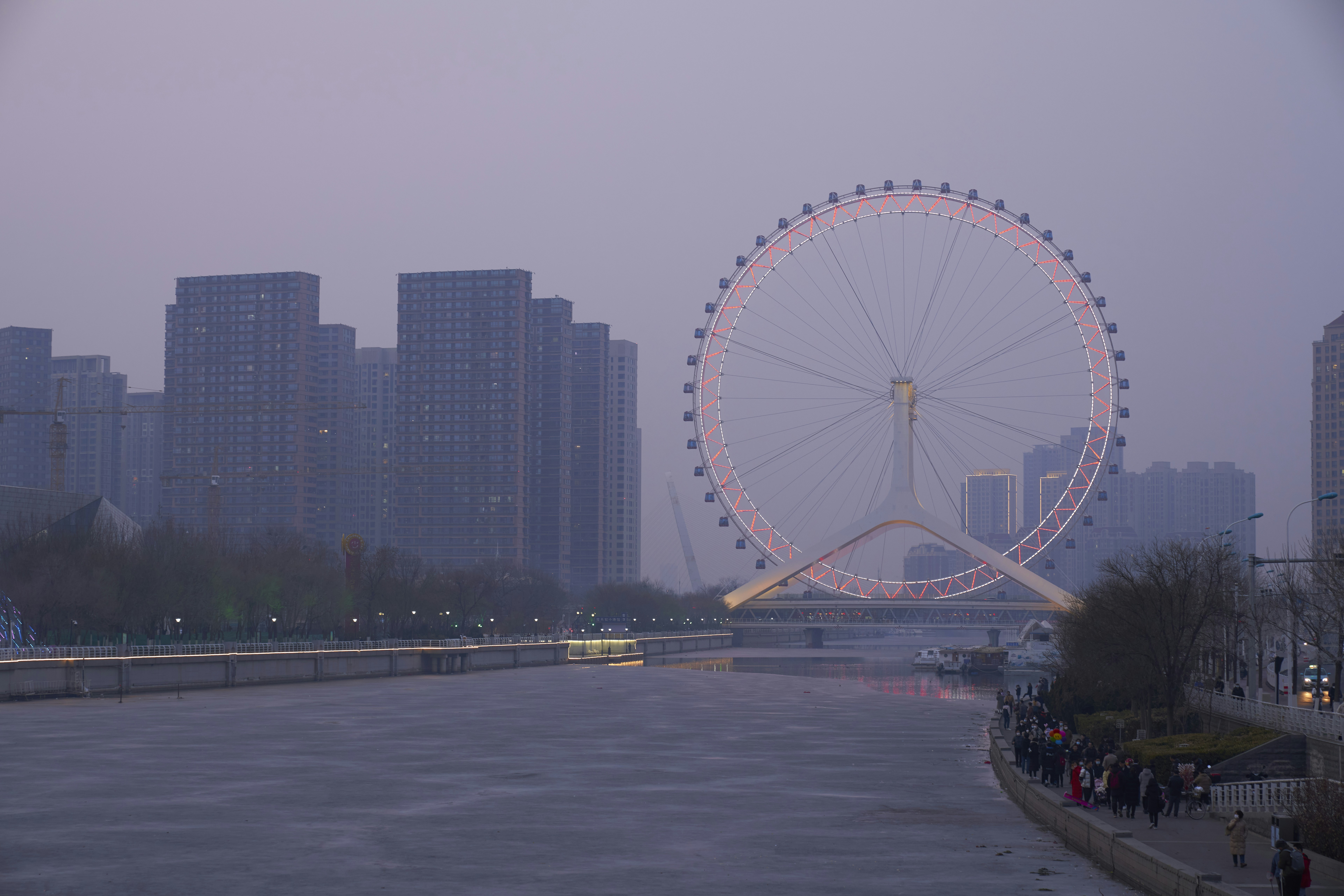 Twilight Ferris Wheel Over River Cityscape