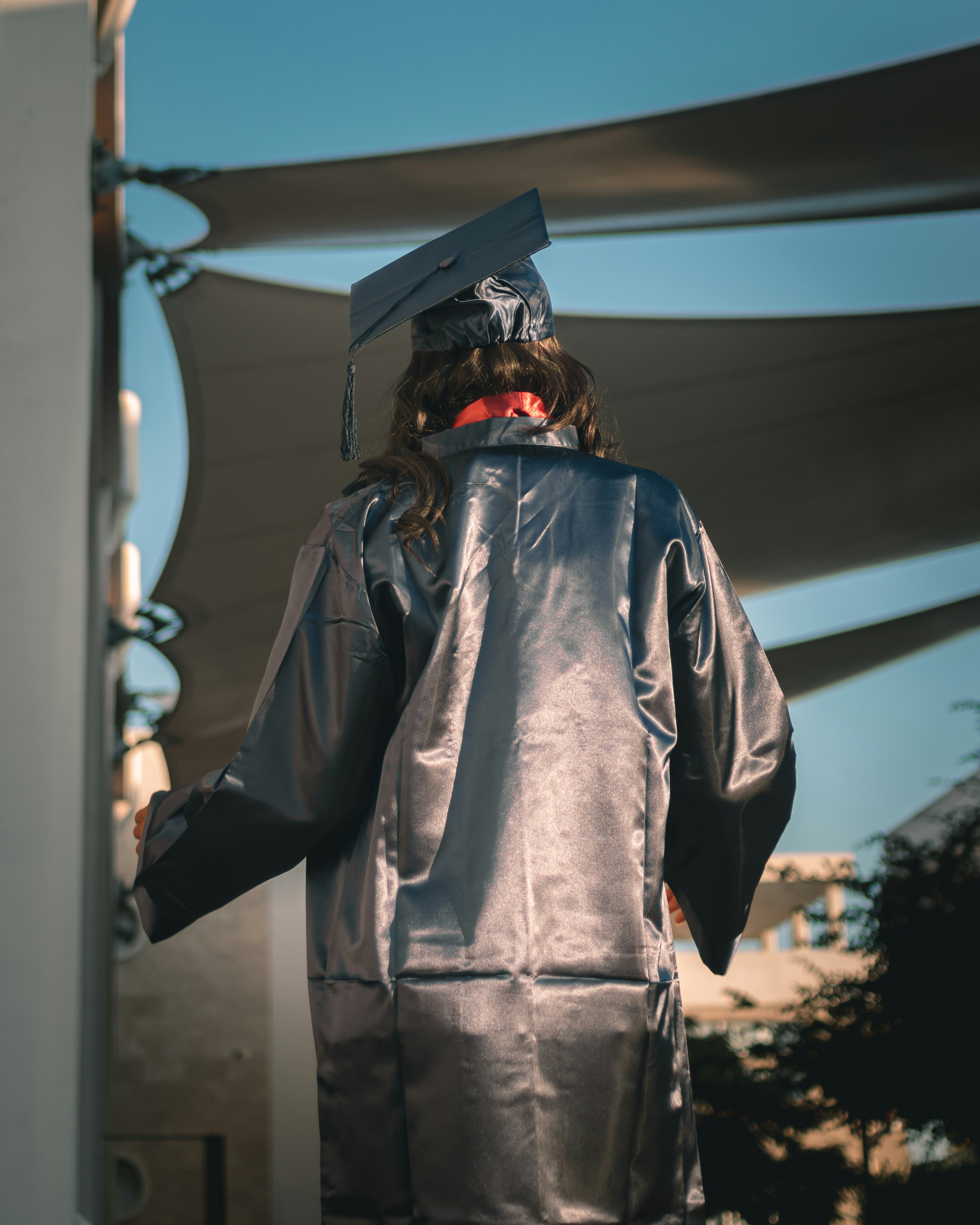 Graduation in Backlit Silhouette: A Back View of a Graduate