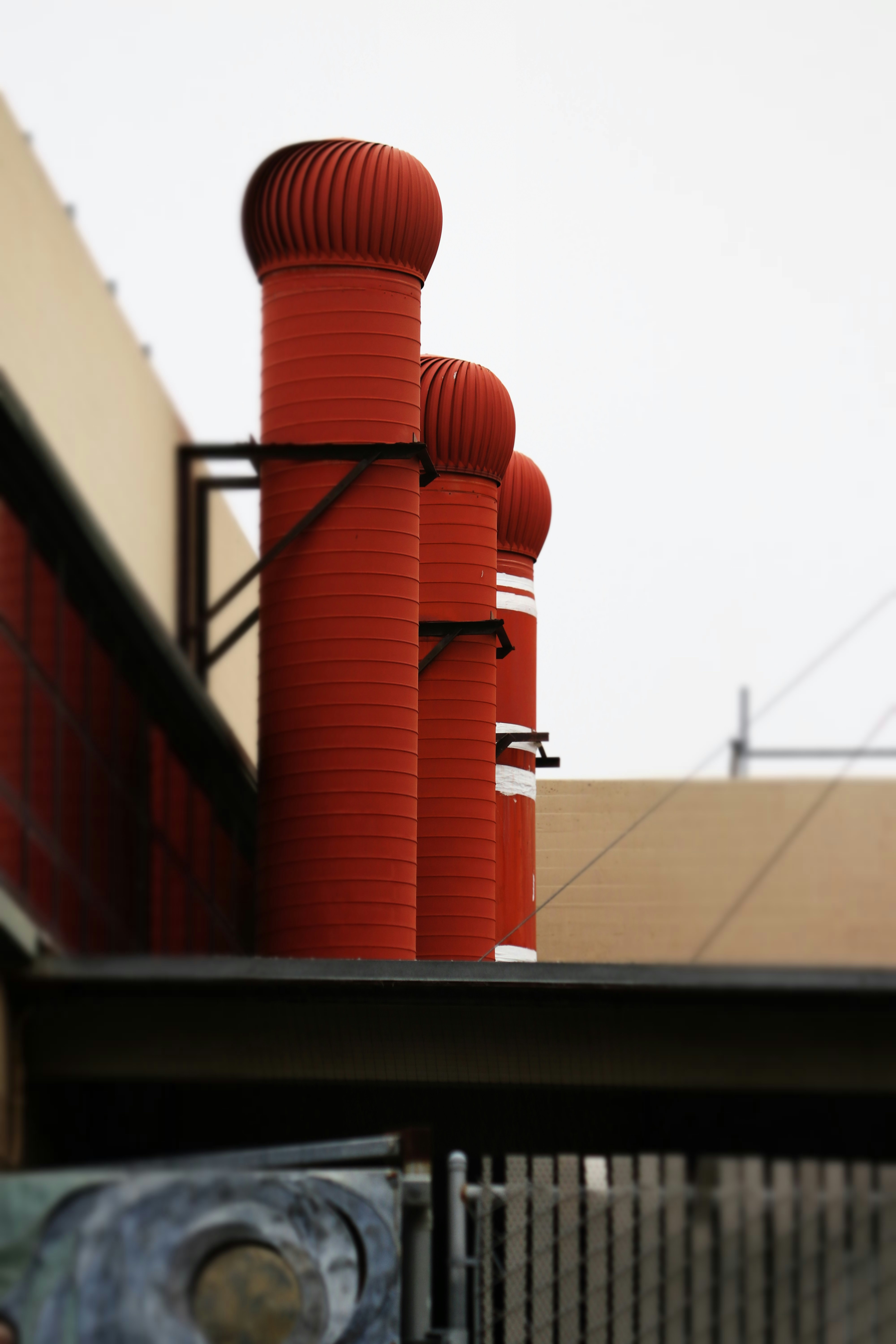 Crimson Vents Rising: A Quiet Industrial Portrait