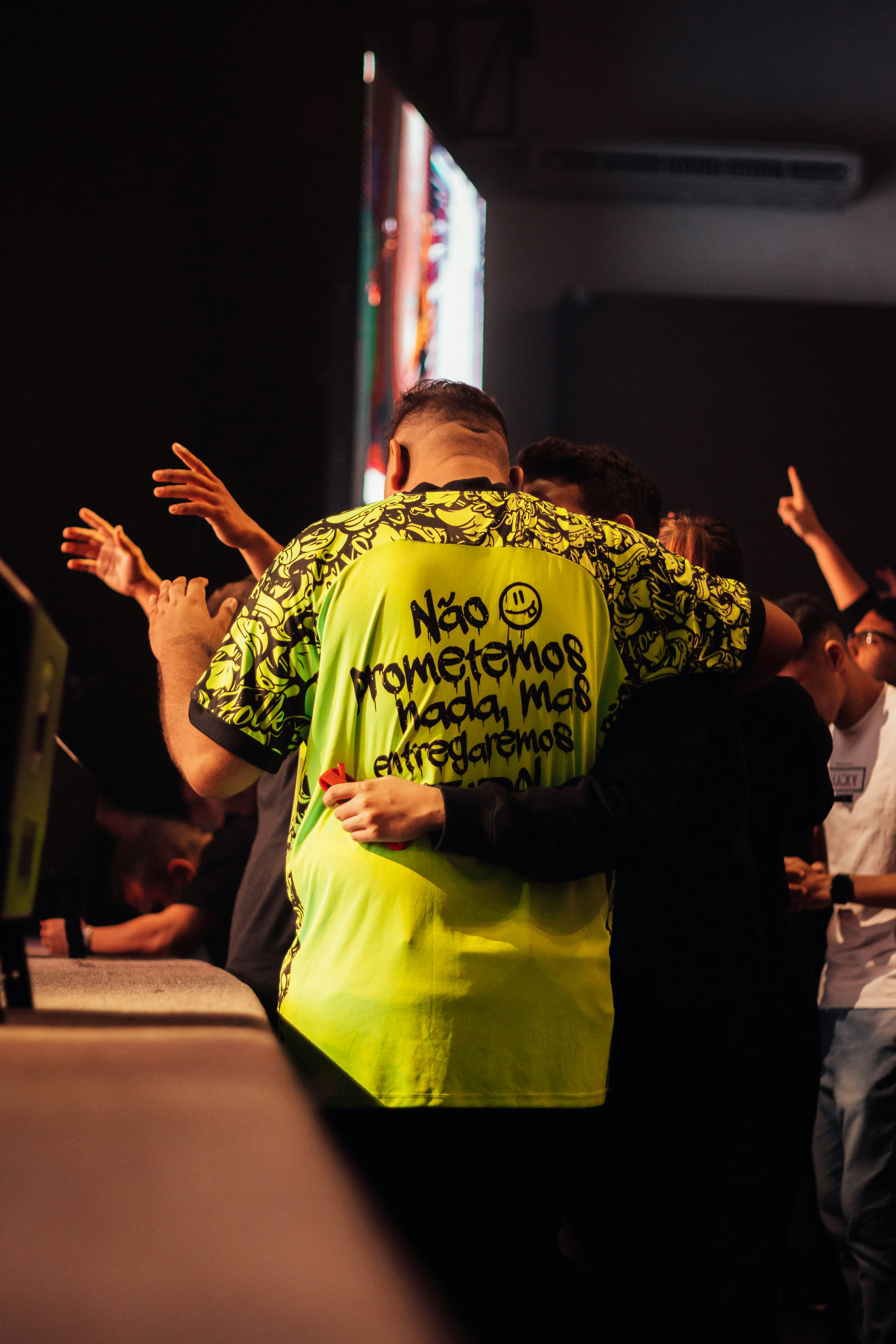 Back of the Neon Crowd: A Neon-Jacket Embrace