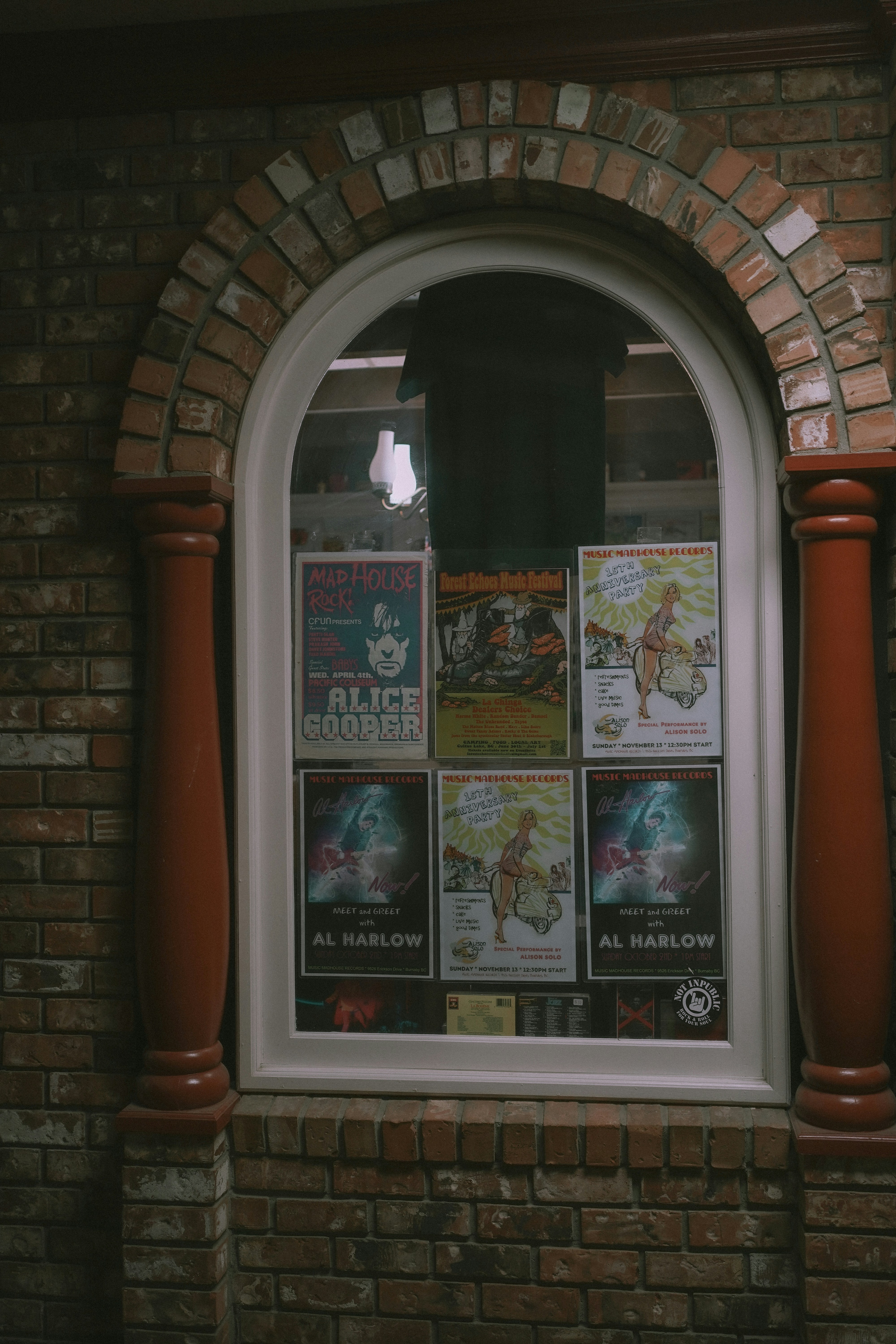 A window with a bunch of posters on it photo – Free Concert poster ...