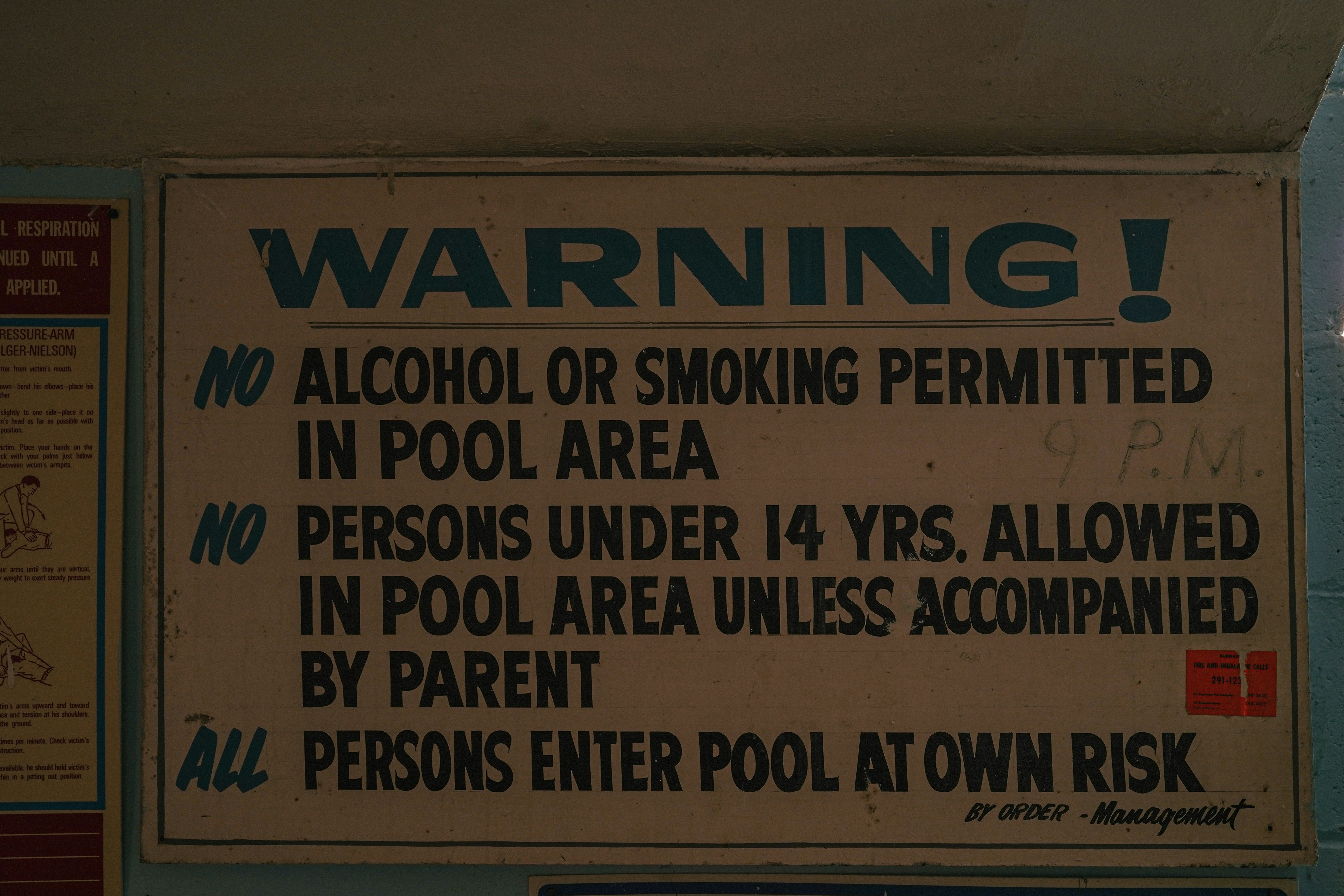 A warning sign posted on the wall of a pool photo – Free Liminal space ...