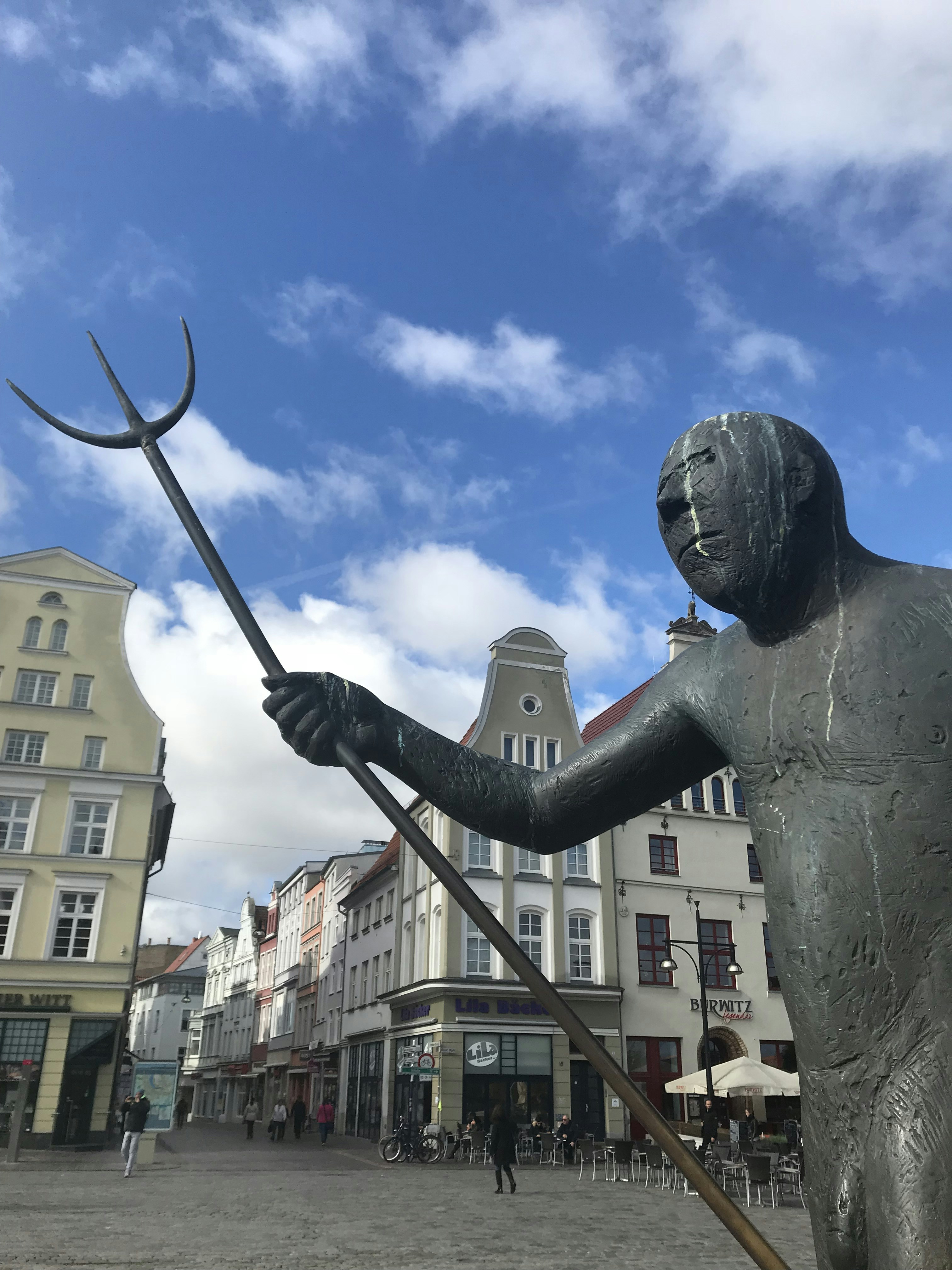 A statue of a man holding a pitchfork photo – Free Rostock Image on ...