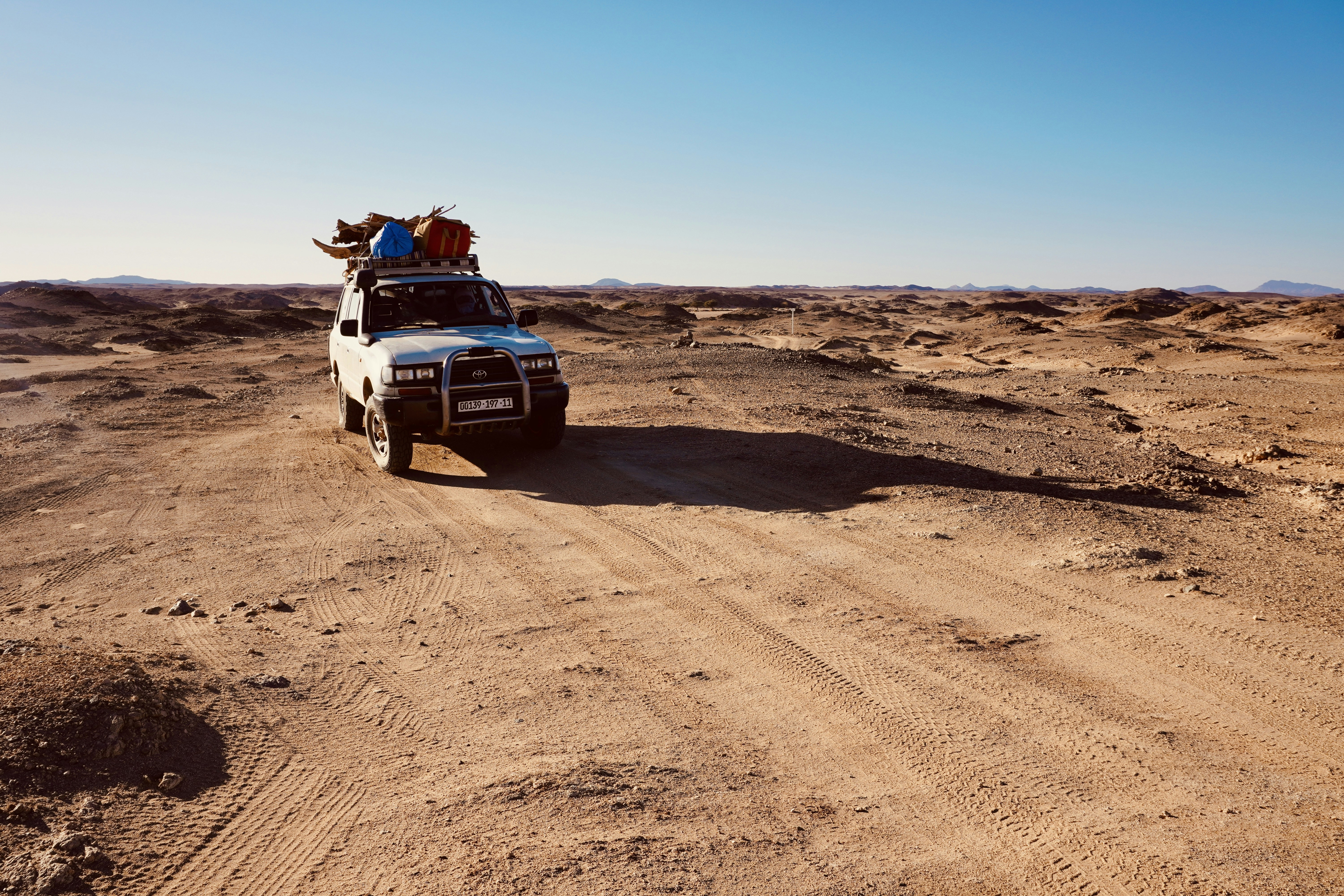 A pick up truck with luggage on top of it in the desert photo – Free ...