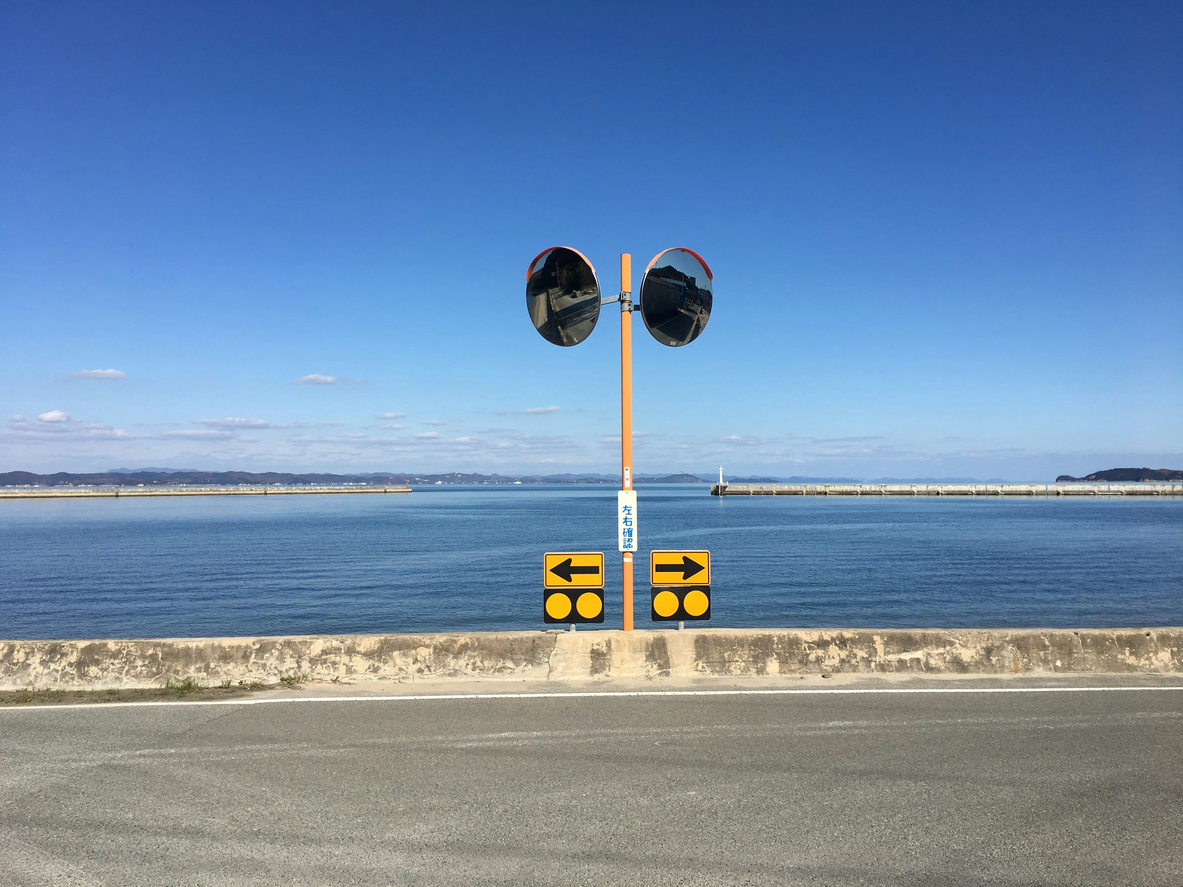 Harbor Signpost and Mirror Duo Over Calm Water