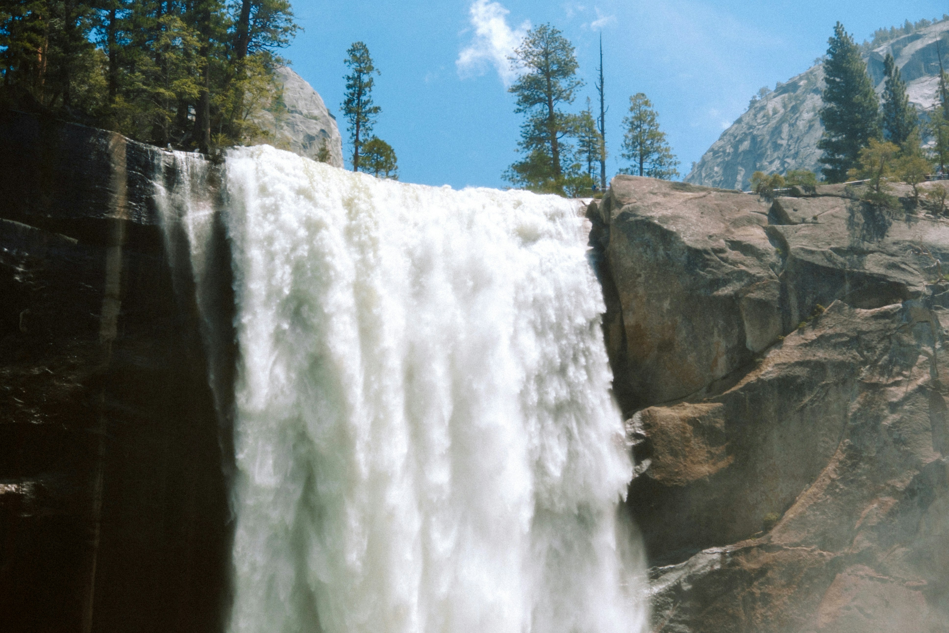 A large waterfall with water cascading down it's sides photo – Free ...