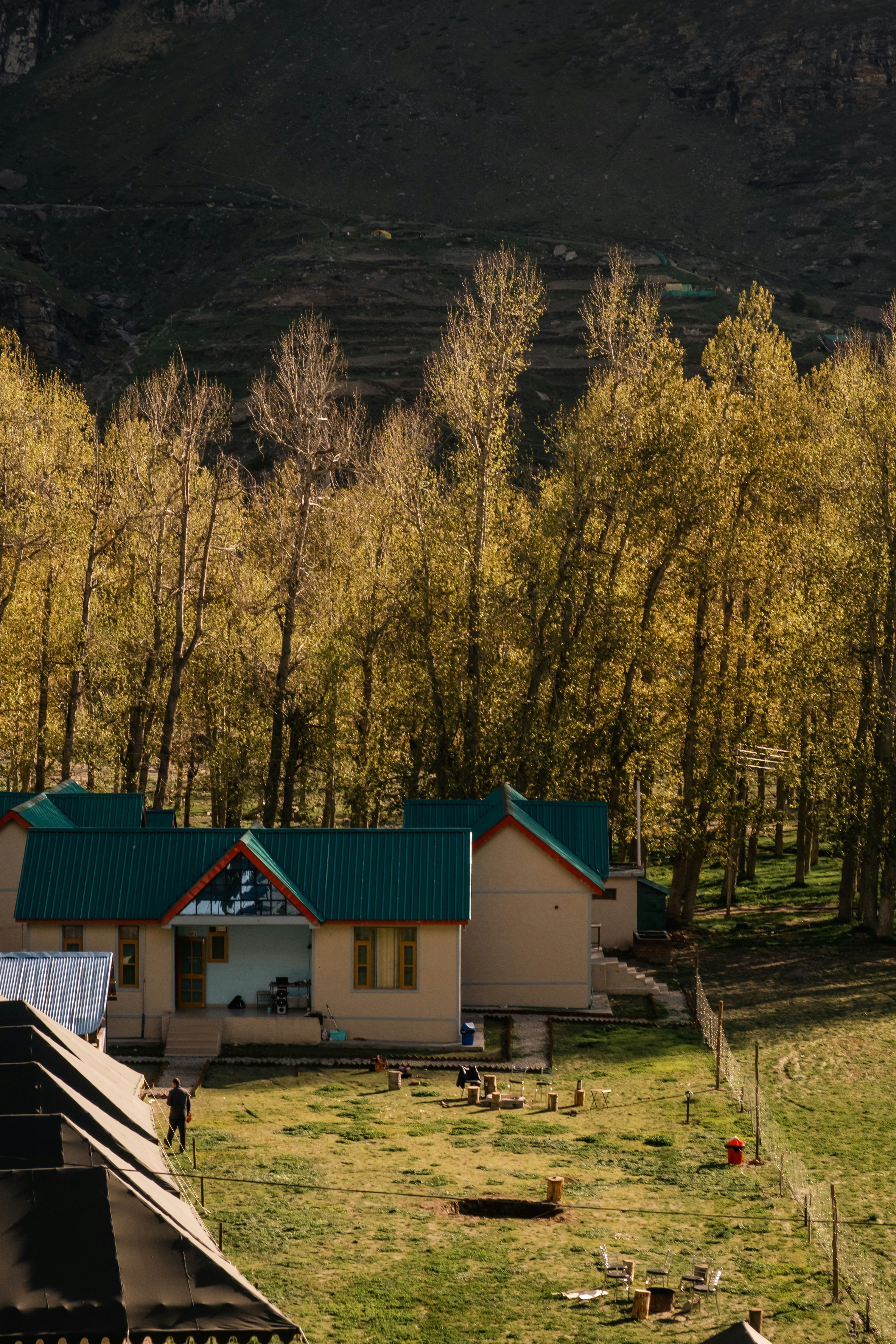 Teal-Rooed Cottages Framed by Autumn Aspens