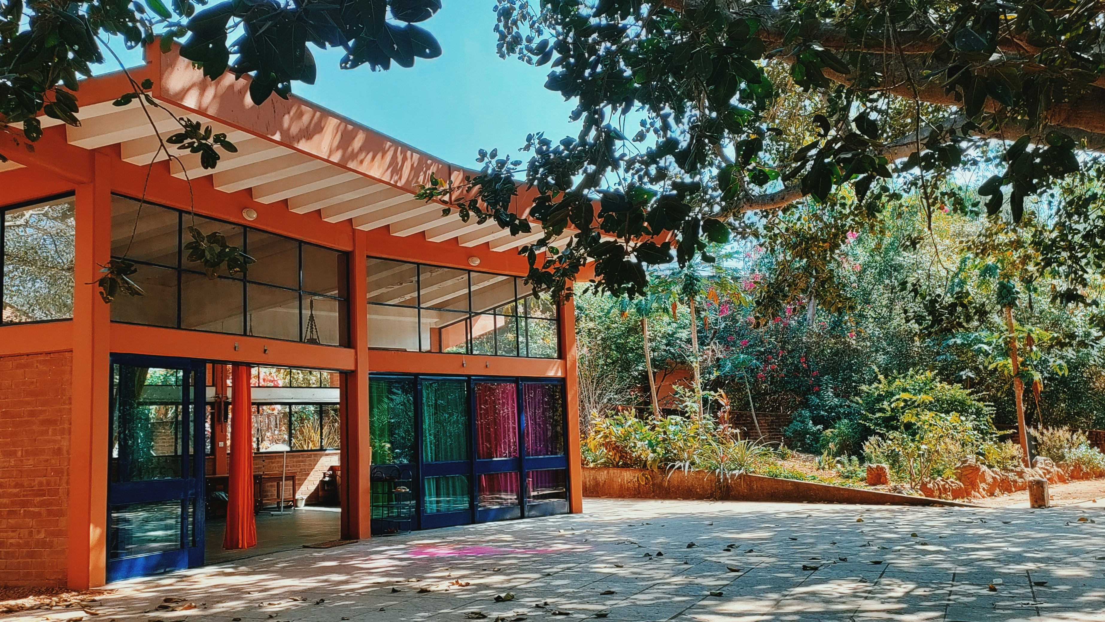 An orange building with glass doors and a roof photo – Free Puducherry ...