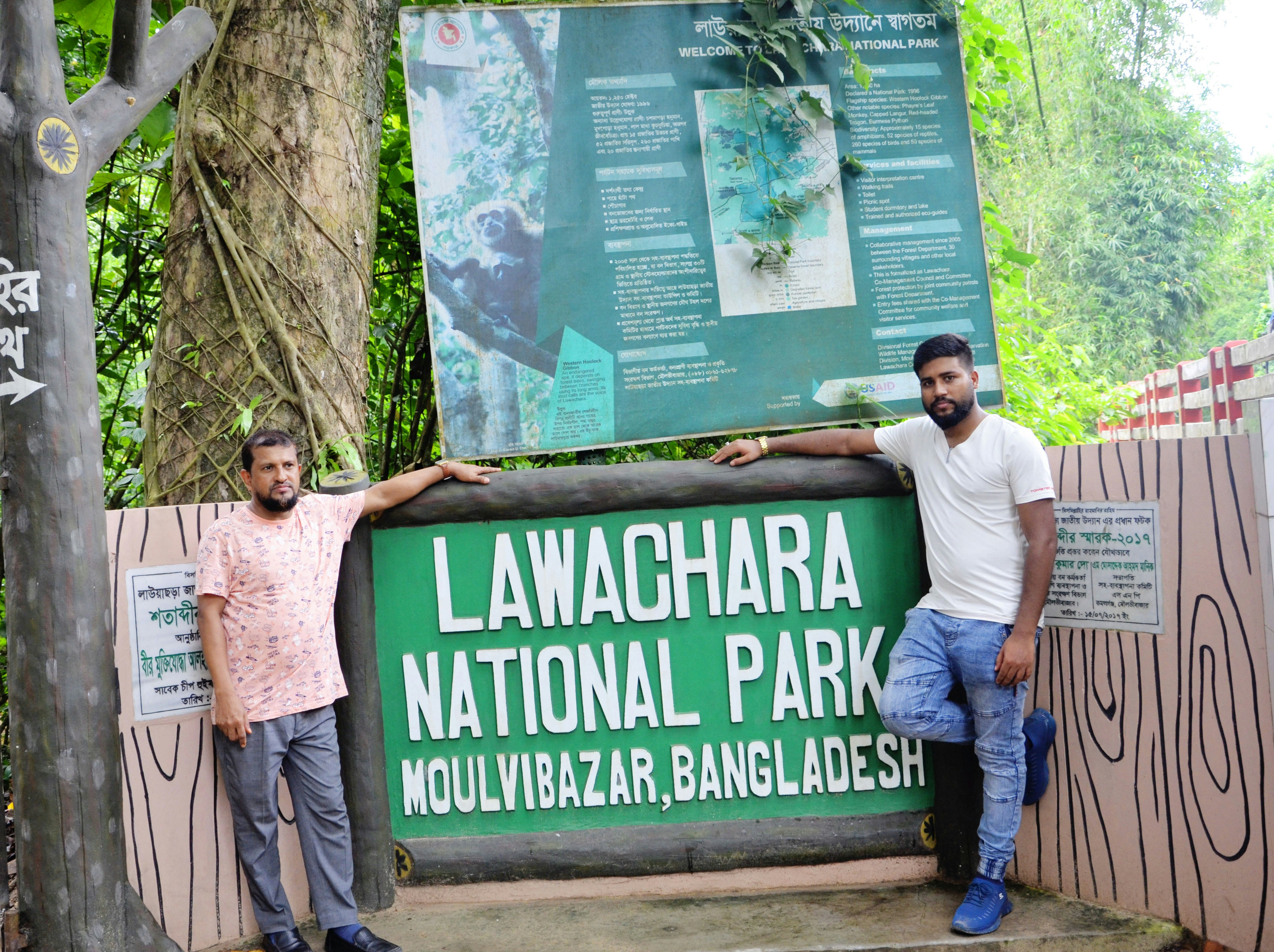 A couple of men standing next to a sign photo – Free Photo style Image ...
