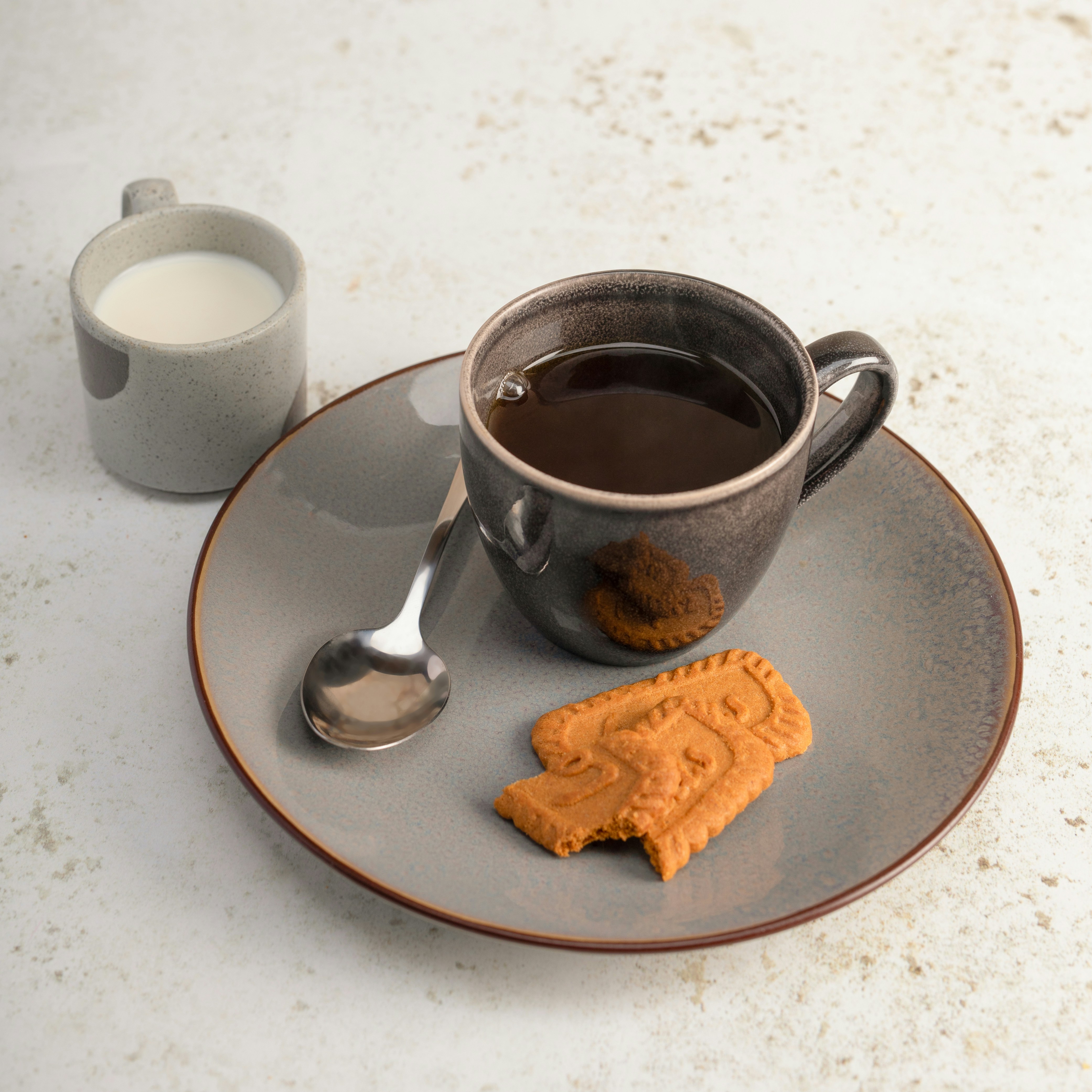 Quiet Morning Ritual: Dark Coffee, Milk, and Cookies on a Matte Plate