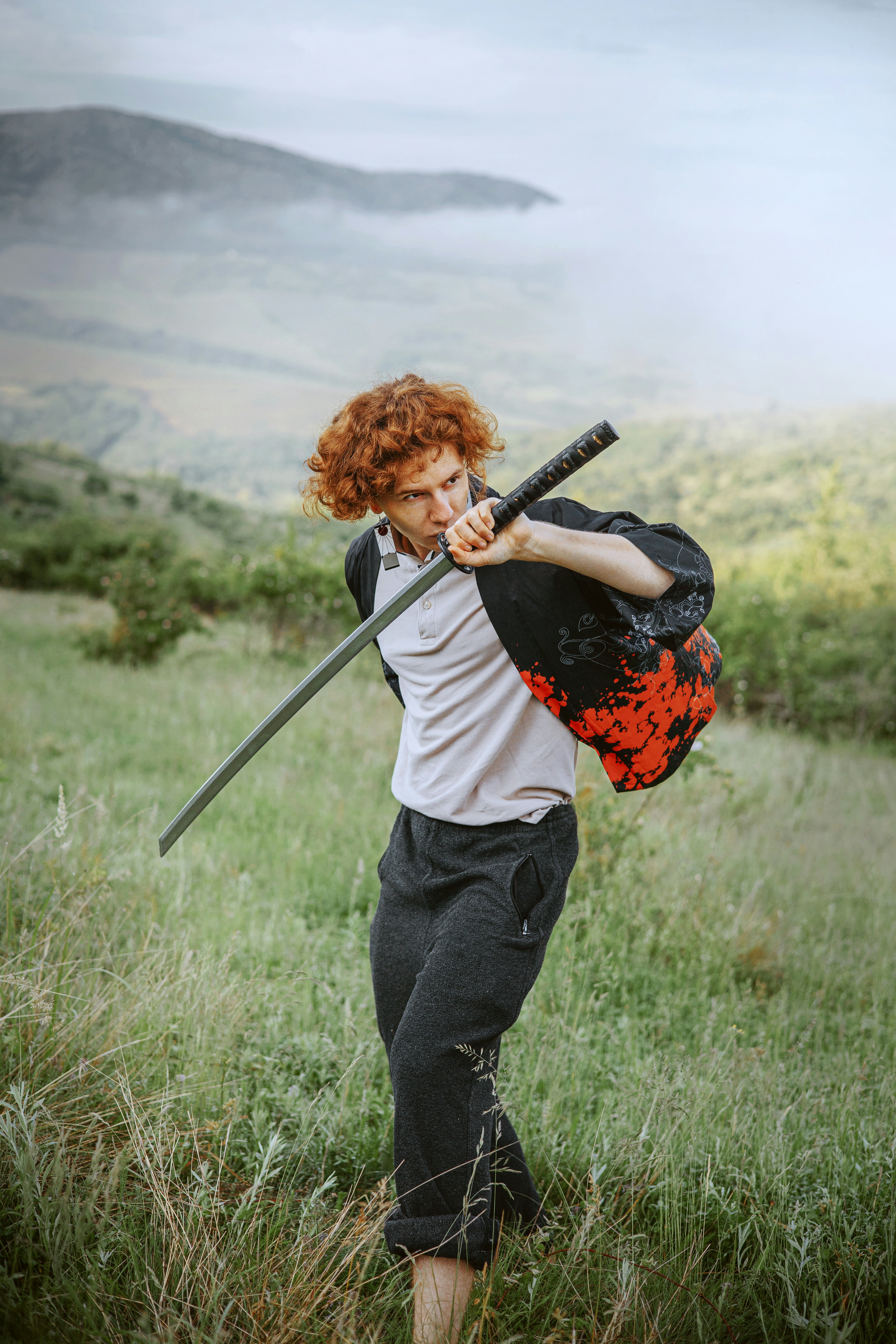 A man with red hair is holding a sword photo – Free Arad Image on Unsplash