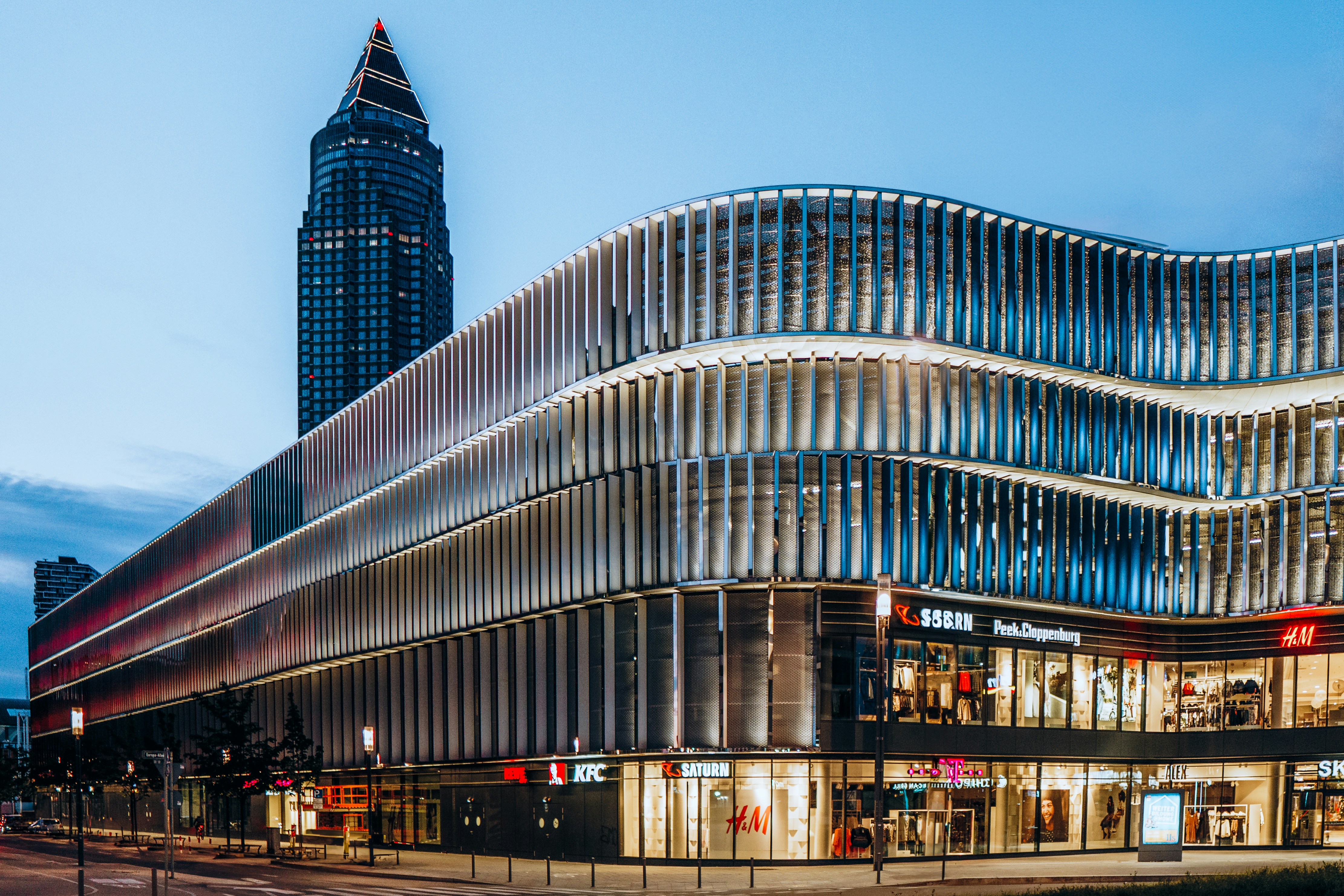 A large building with a curved metal facade photo – Free City Image on ...