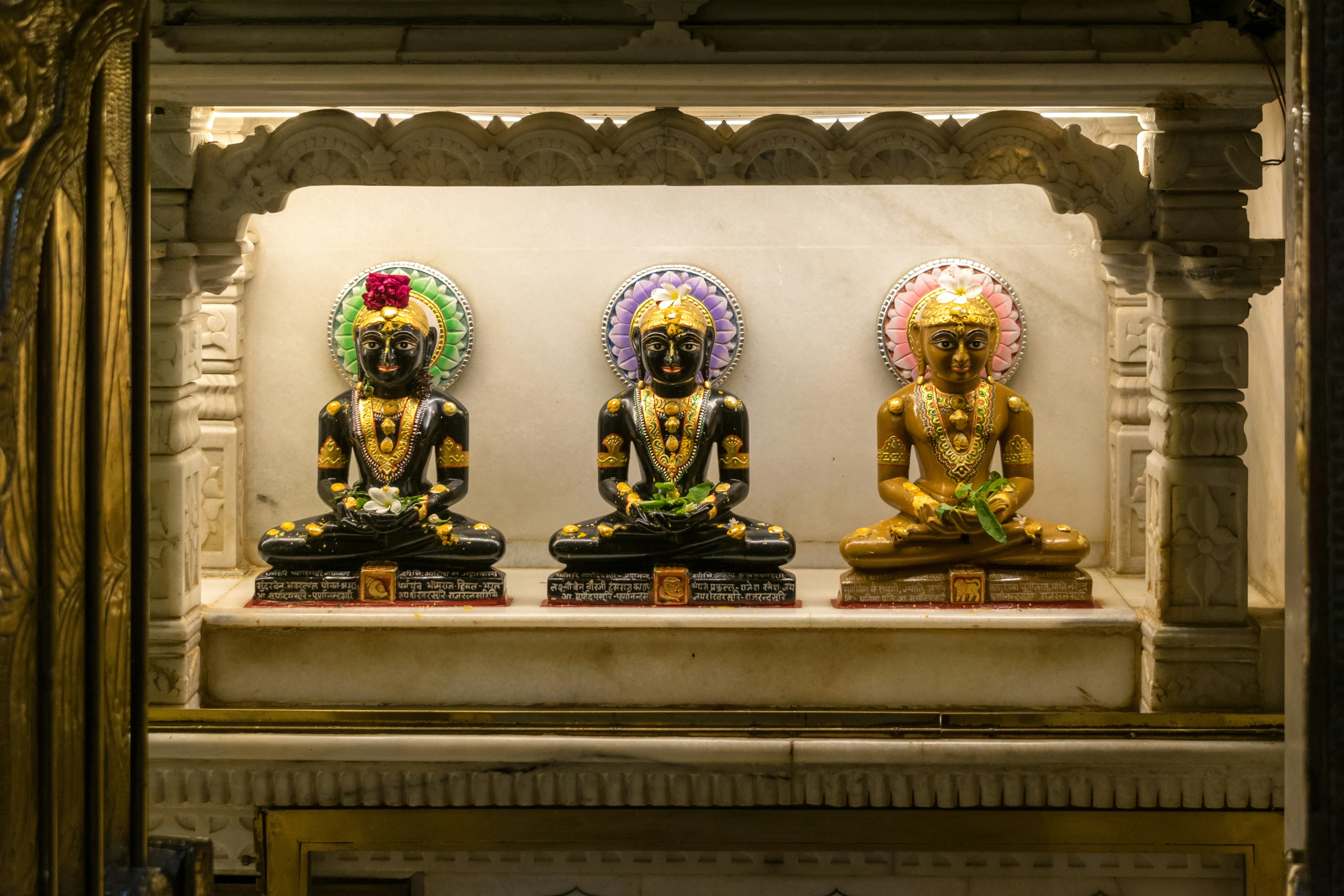 Three statues of buddhas on display in a temple photo – Free ...
