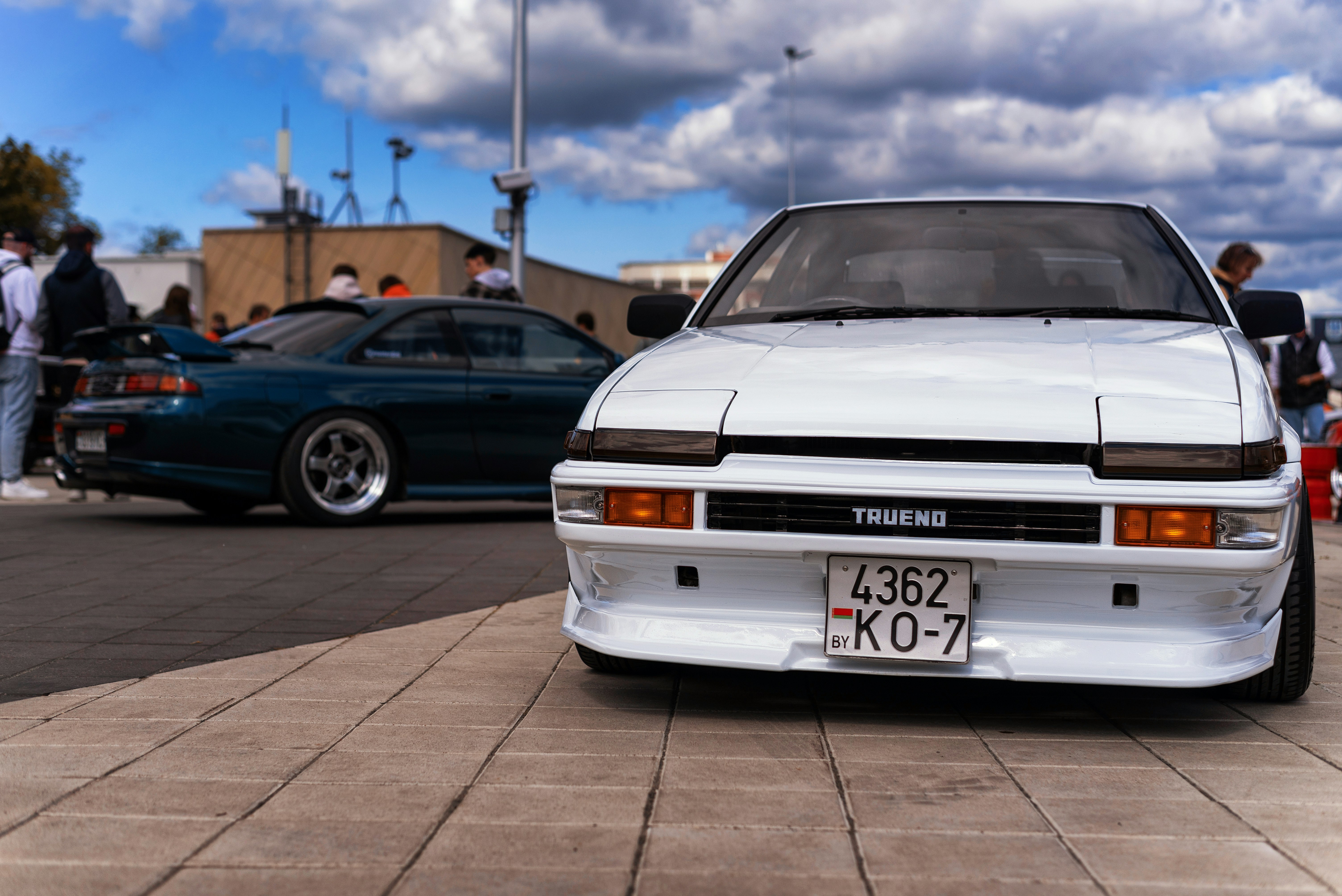 White Toyota Trueno at a car meet: front bumper and license plate in focus