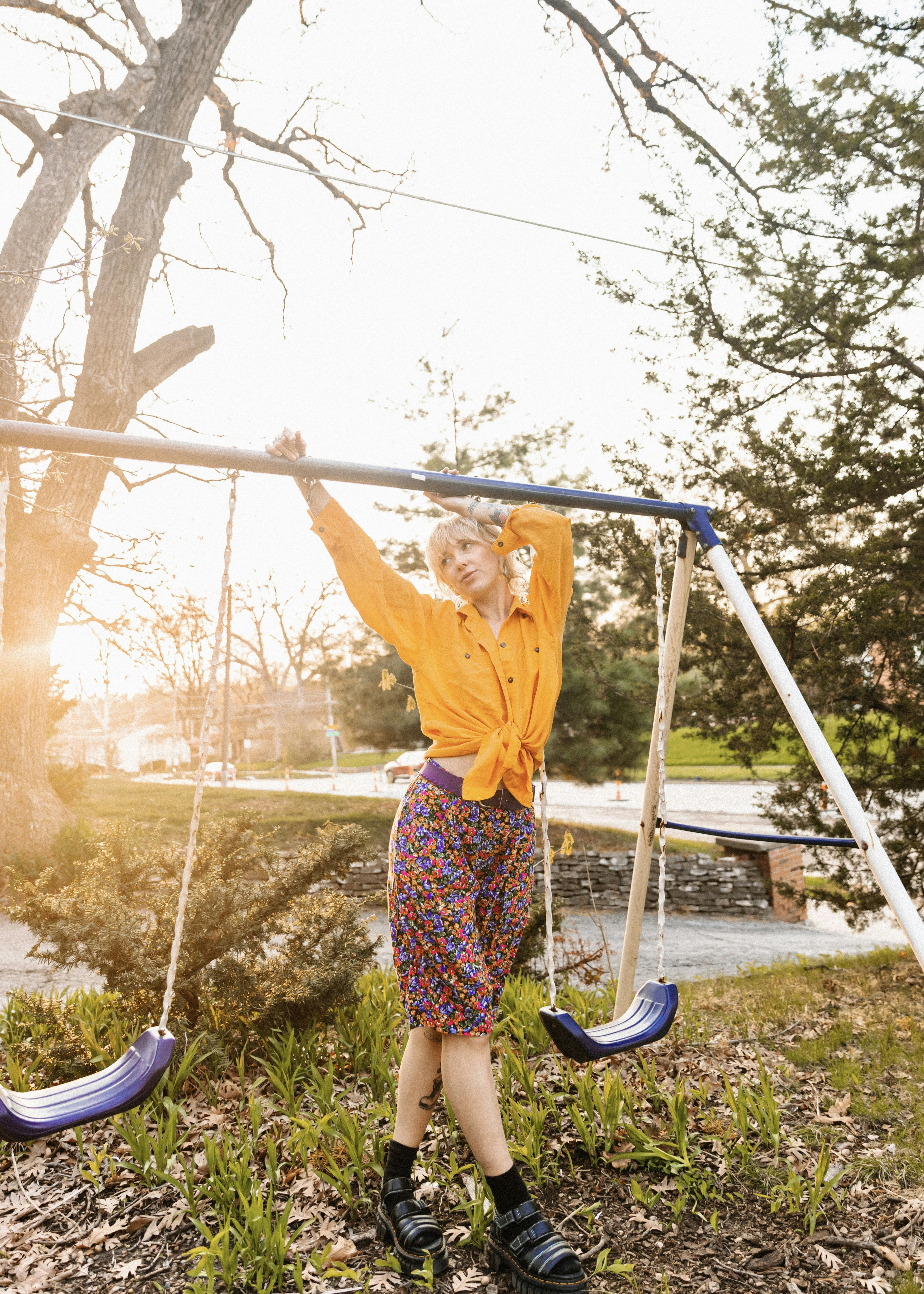 a young girl is swinging on a swing set
