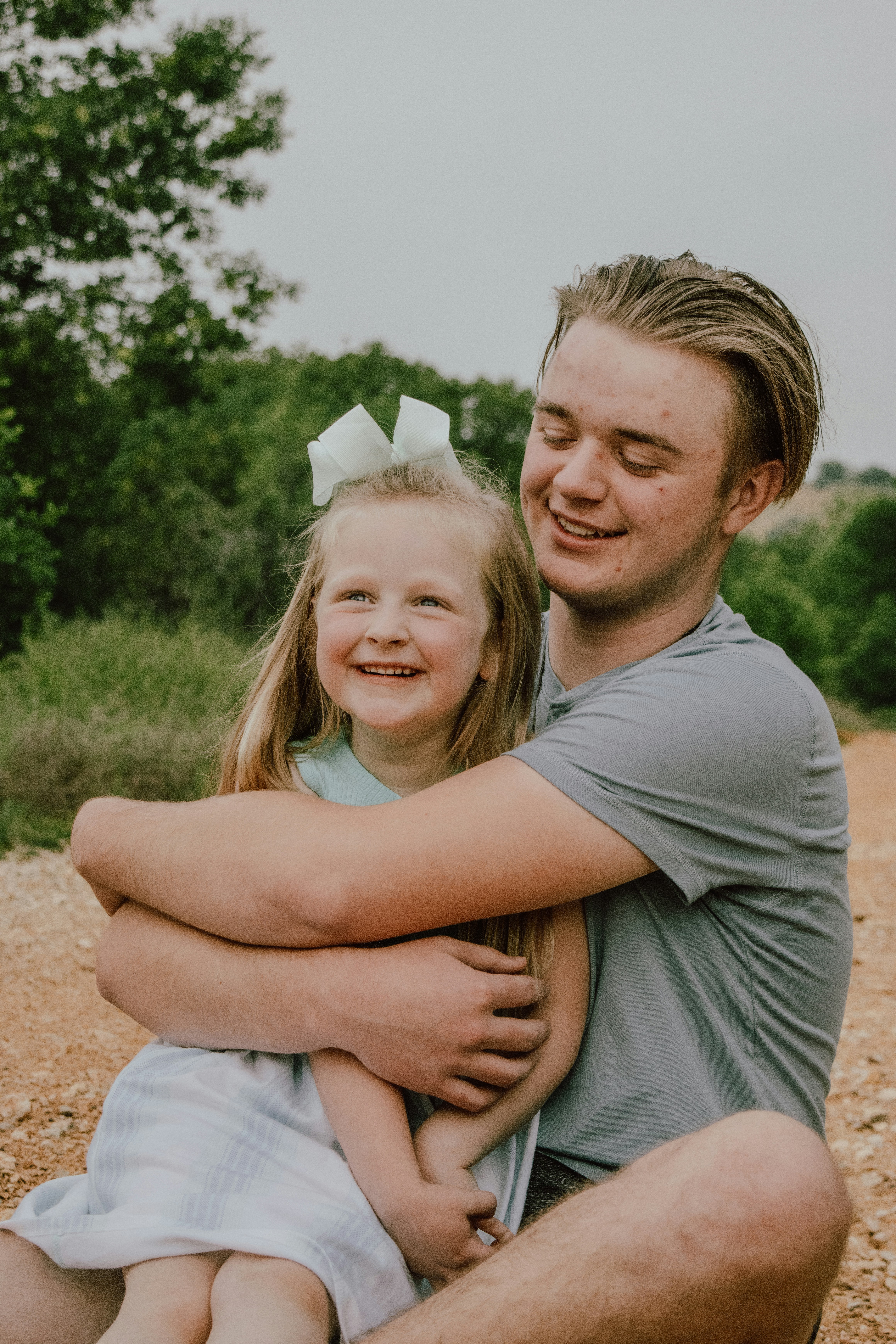a man holding a little girl in his arms