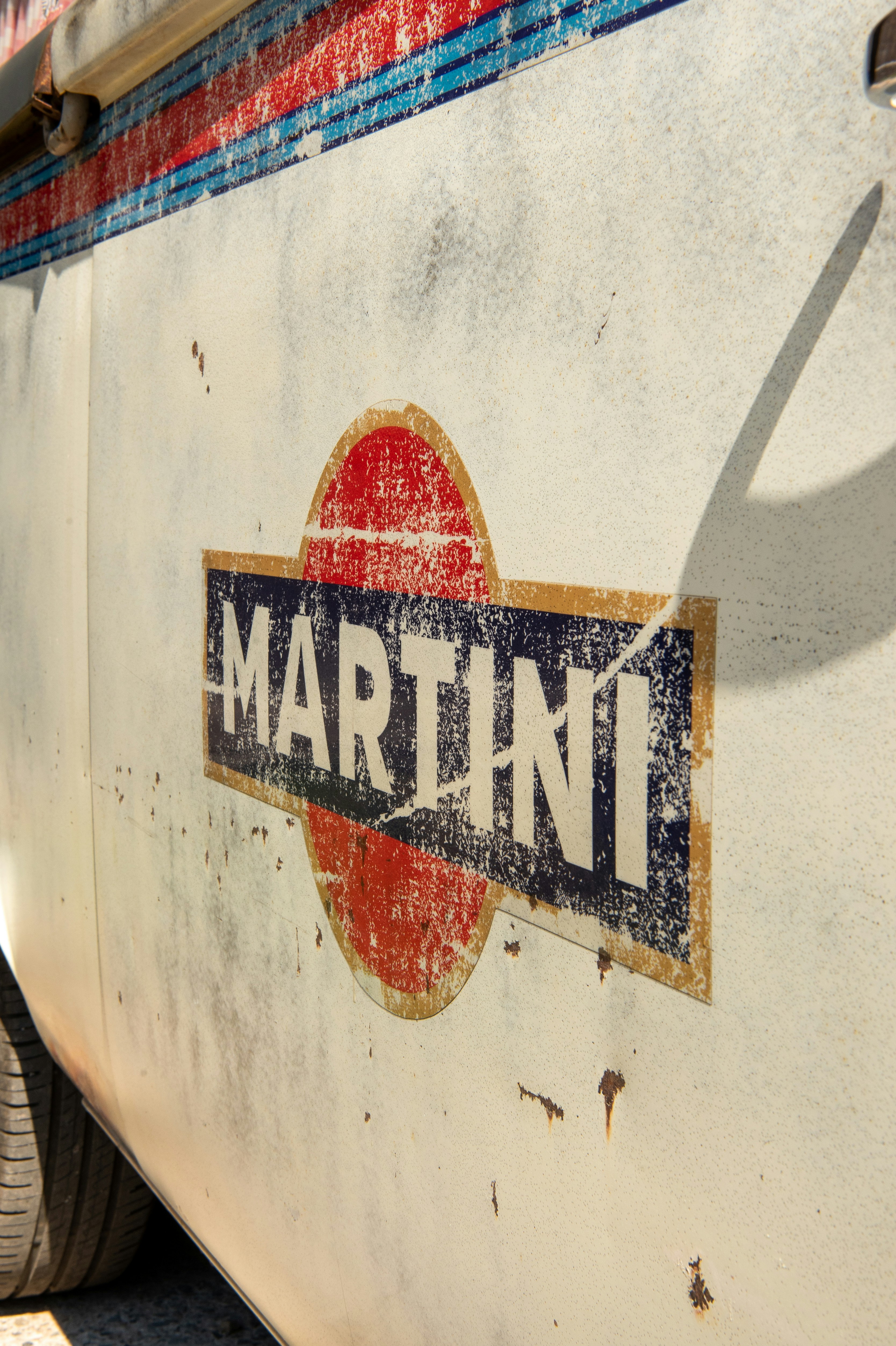 Weathered Martini Emblem on a Sun-Worn Car Door