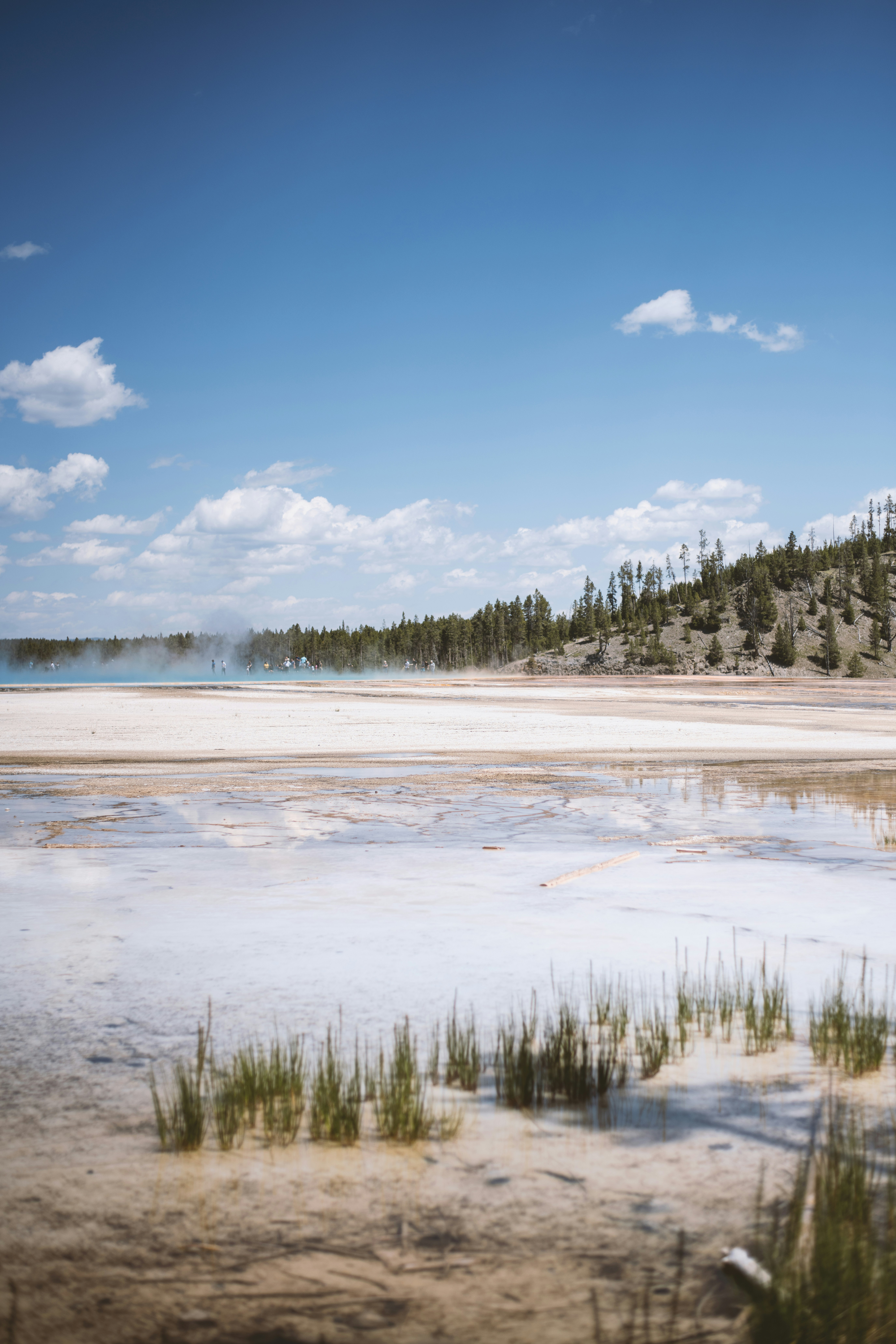 Steam Lifts Over a Pale Salt Flat Beneath a Pristine Alpine Sky