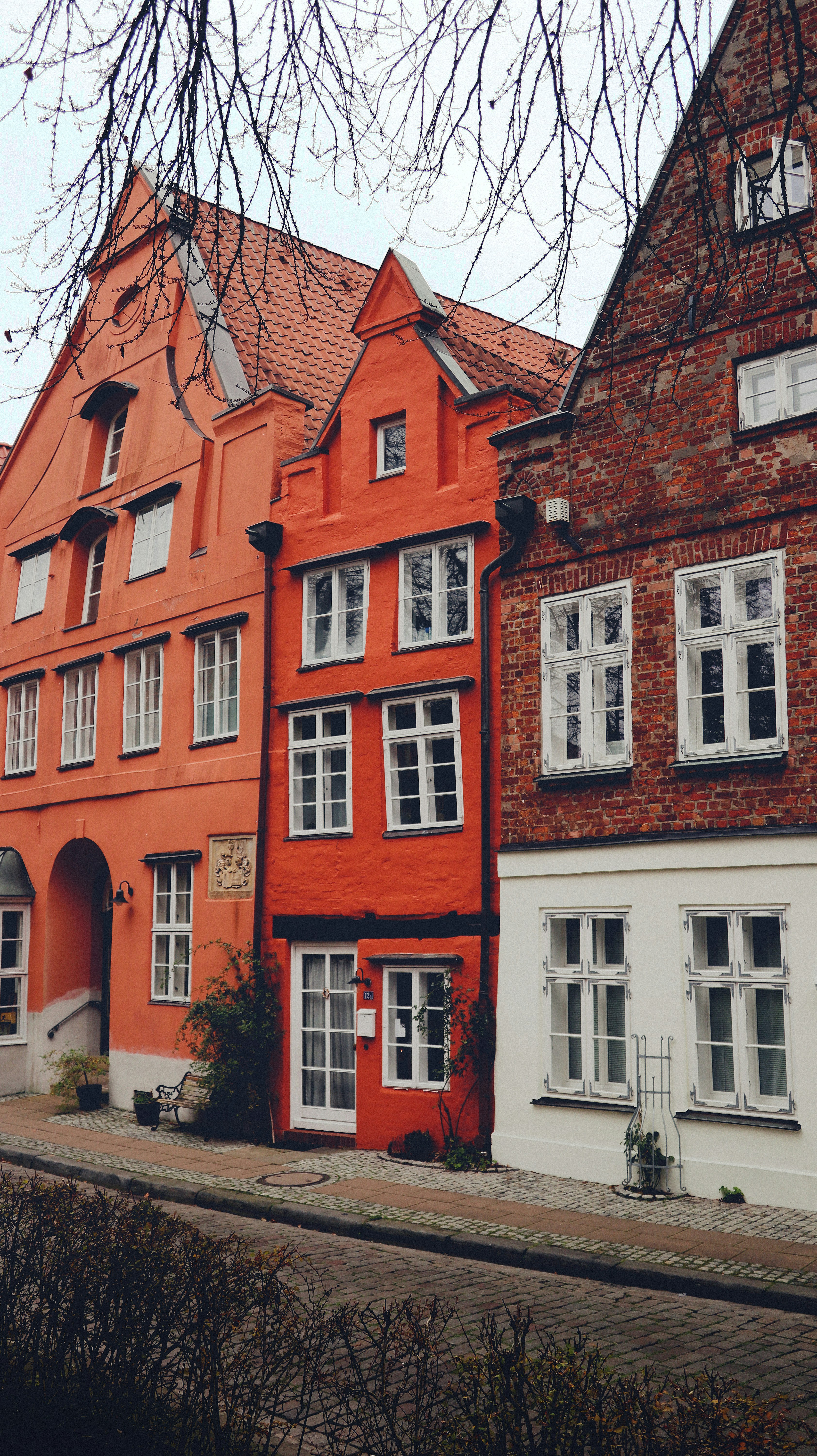 A row of red and white buildings next to each other photo – Free ...