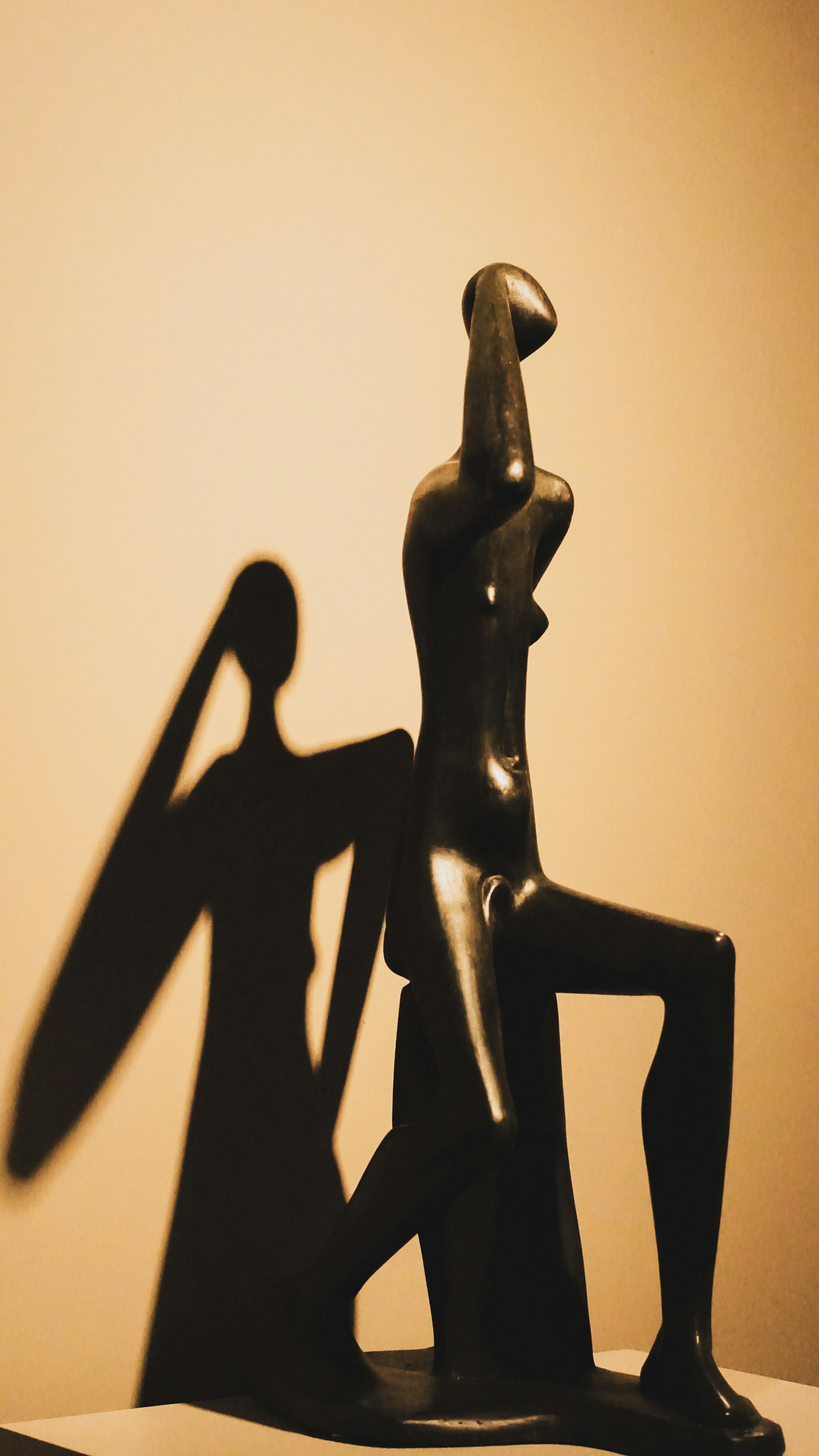 Amber Shadow: A Minimalist Metal Figure Bathed in Warm Light