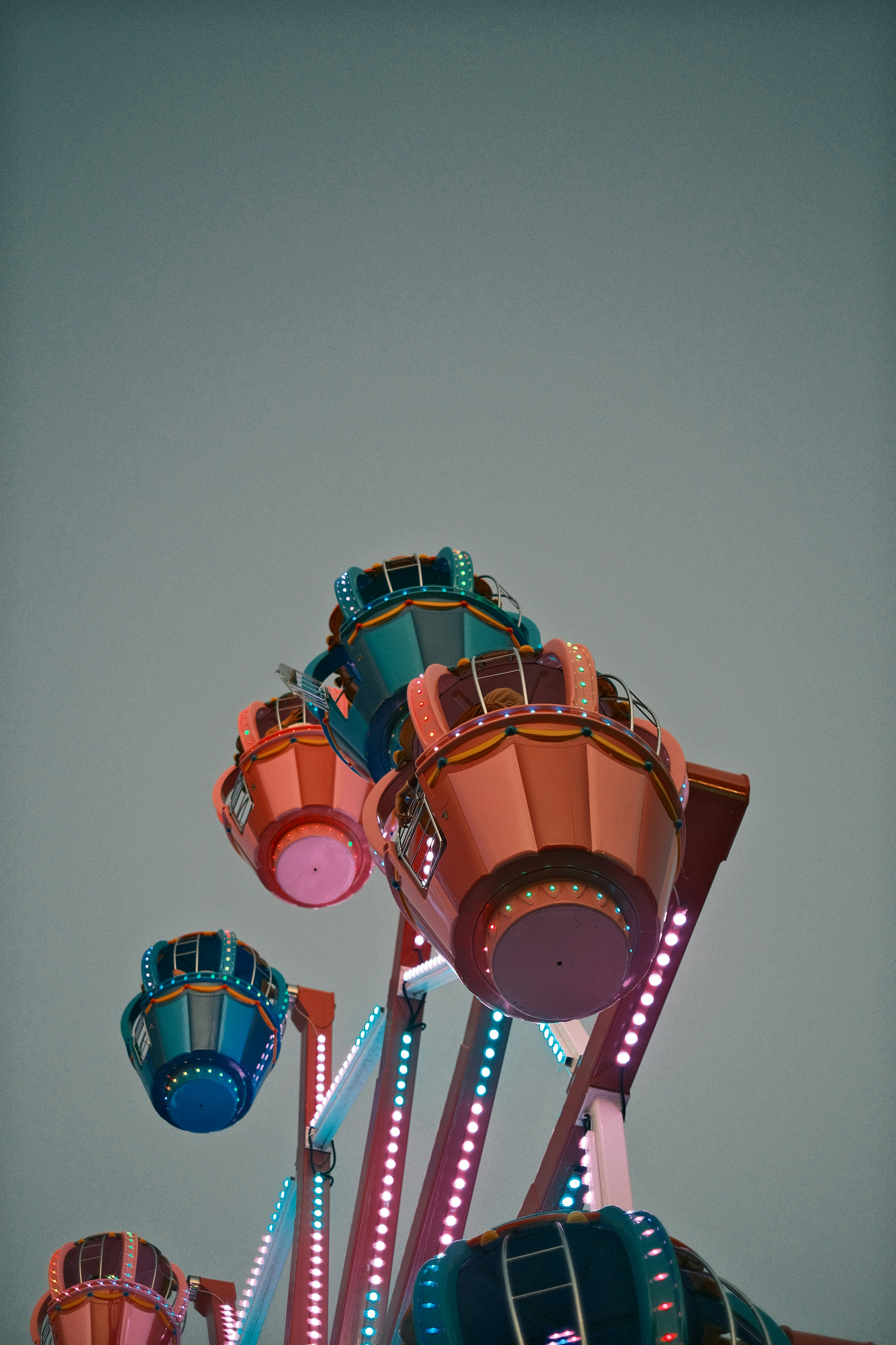 Neon Gondolas Hover Over a Quiet Night Carnival