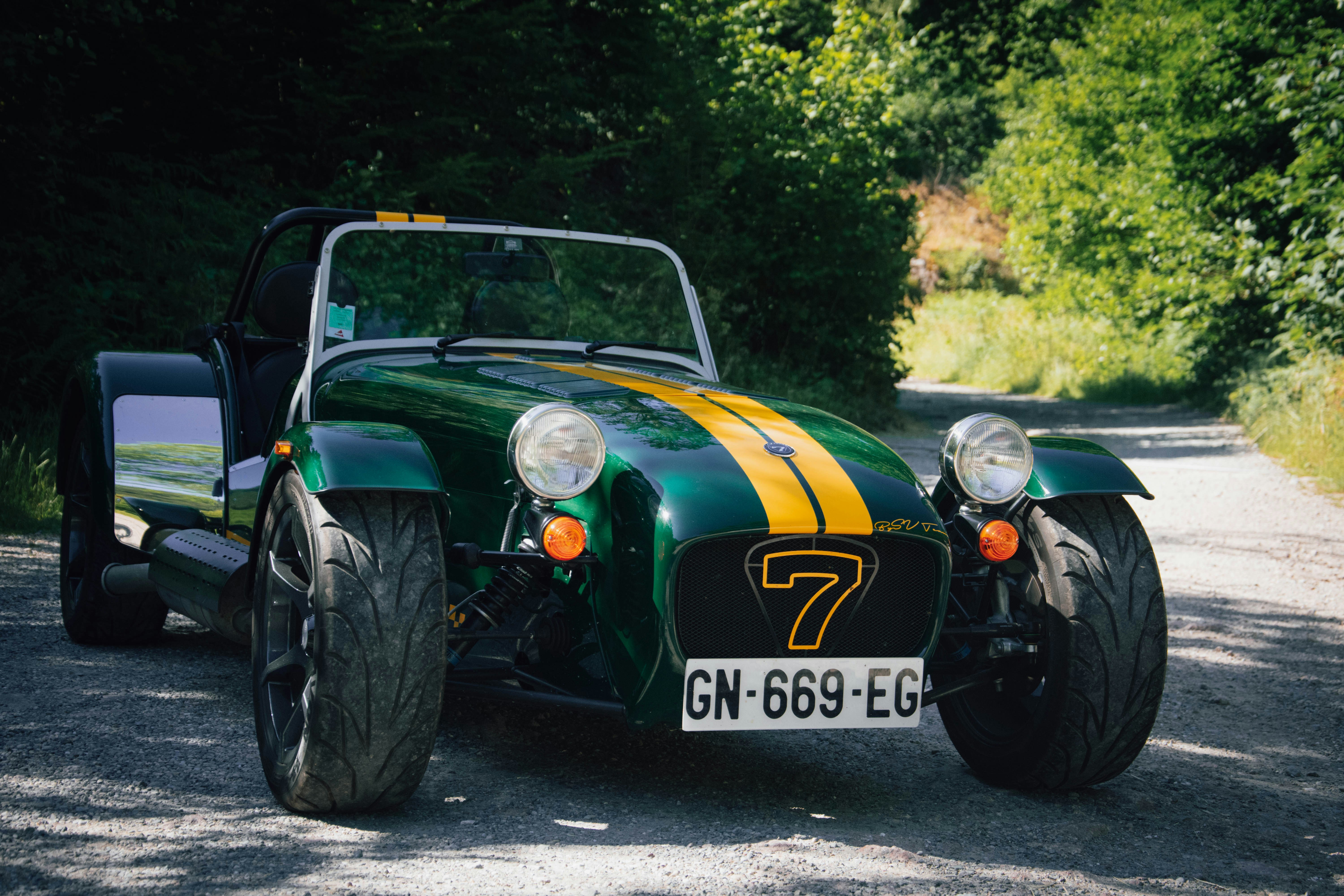 A green and yellow car parked on a gravel road photo – Free France ...