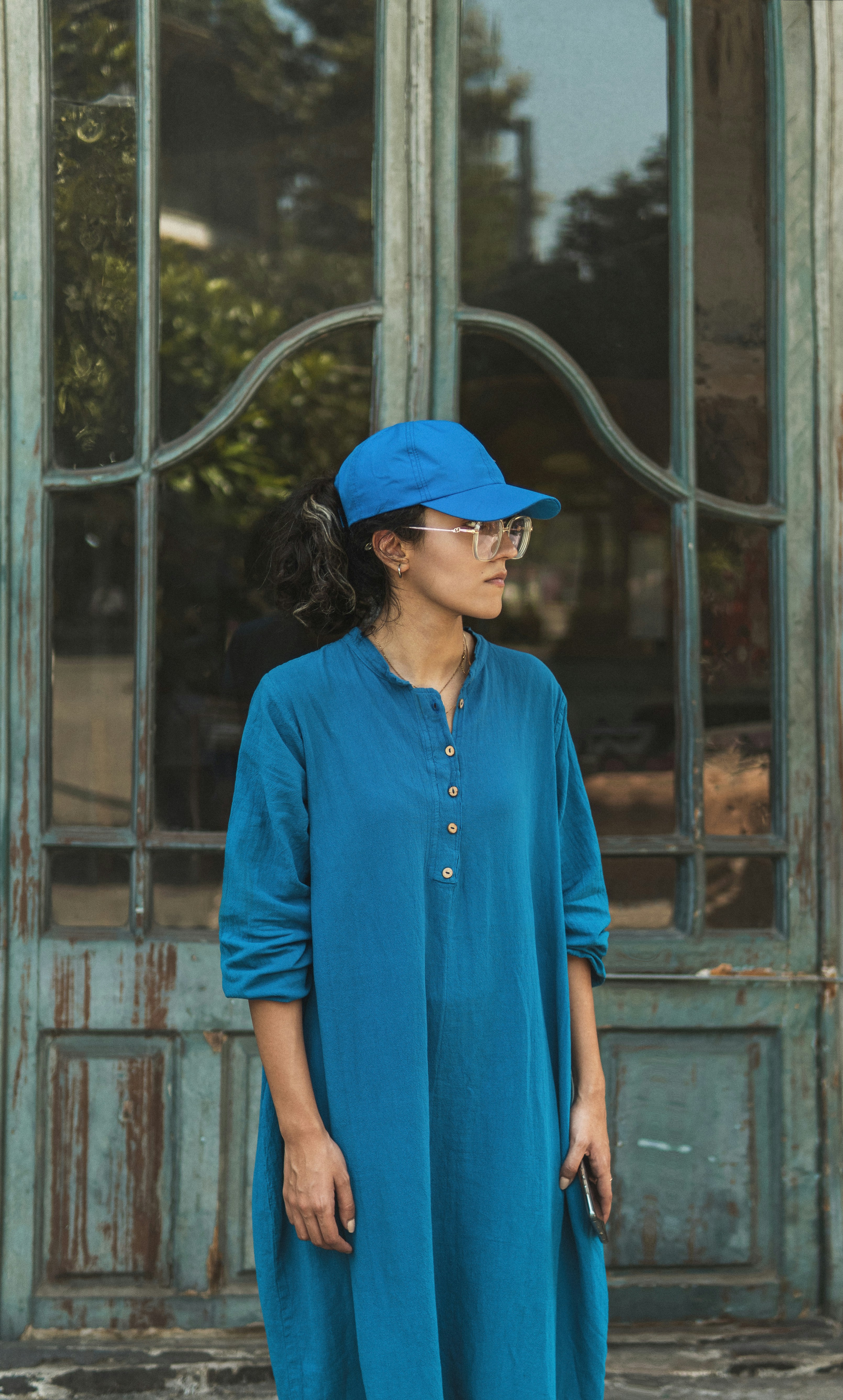 Blue Ensemble in Front of Worn Turquoise Doors