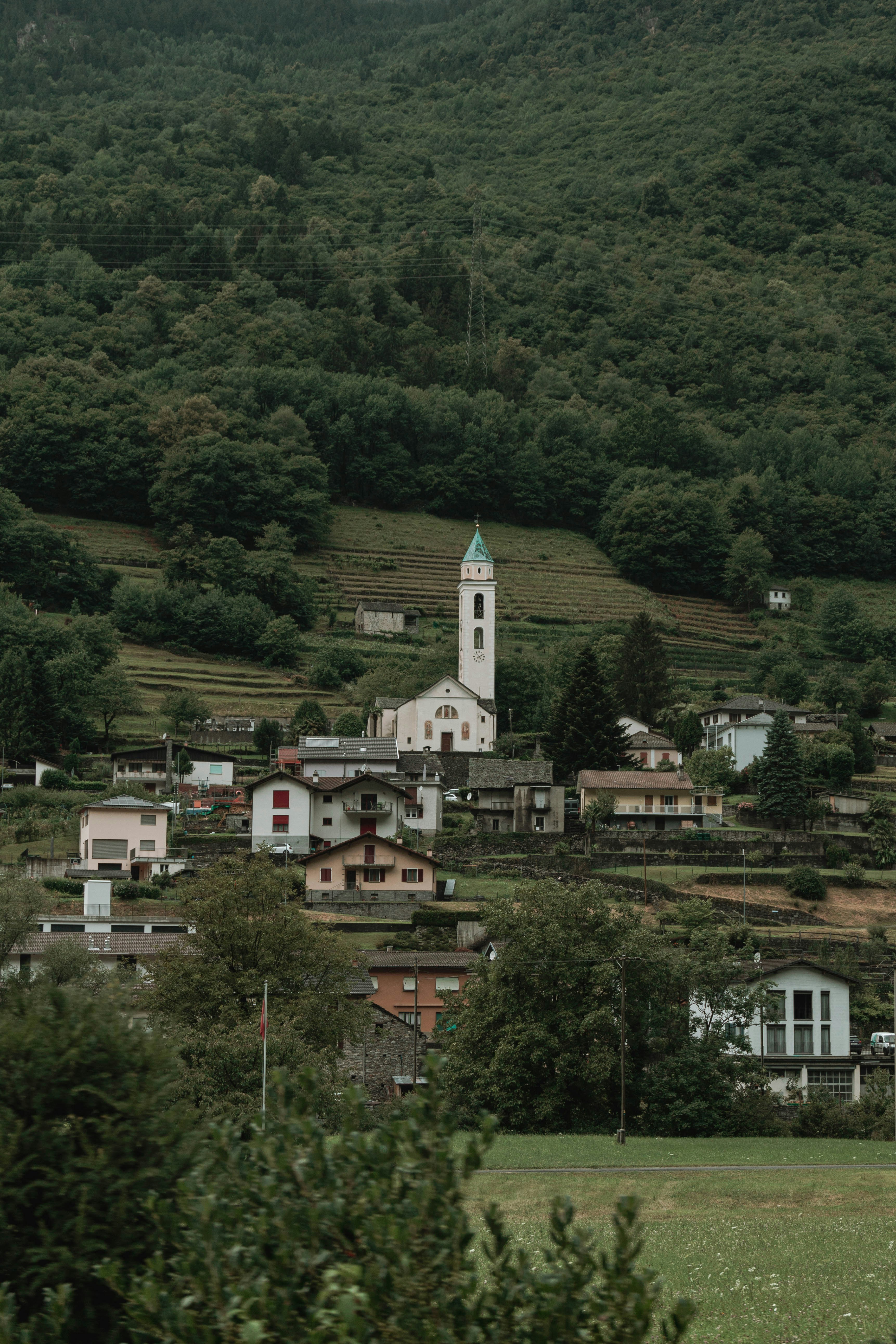 White Church Tower Anchors a Terraced Alpine Village