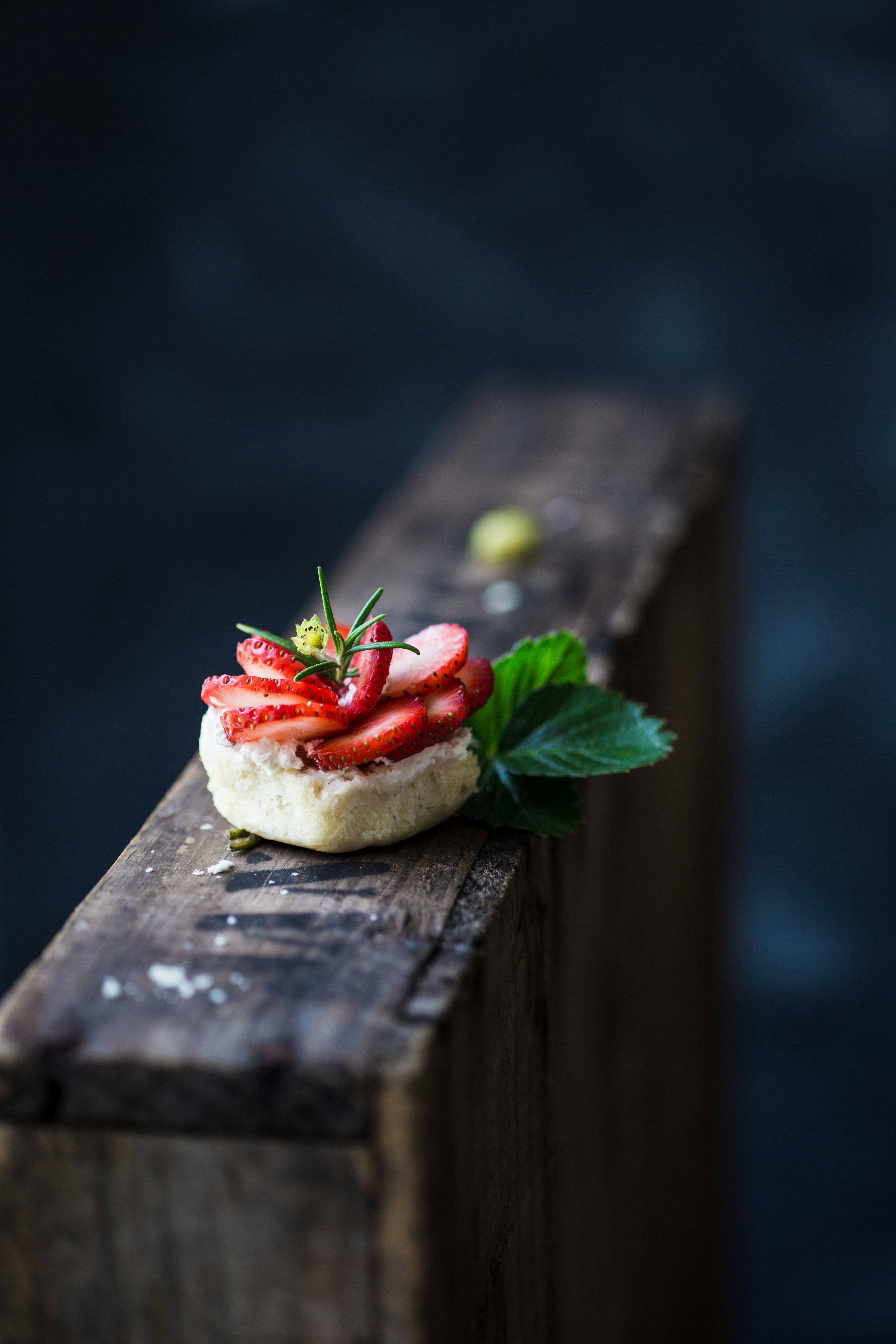 Strawberry-Topped Petite on a Weathered Wood Rail