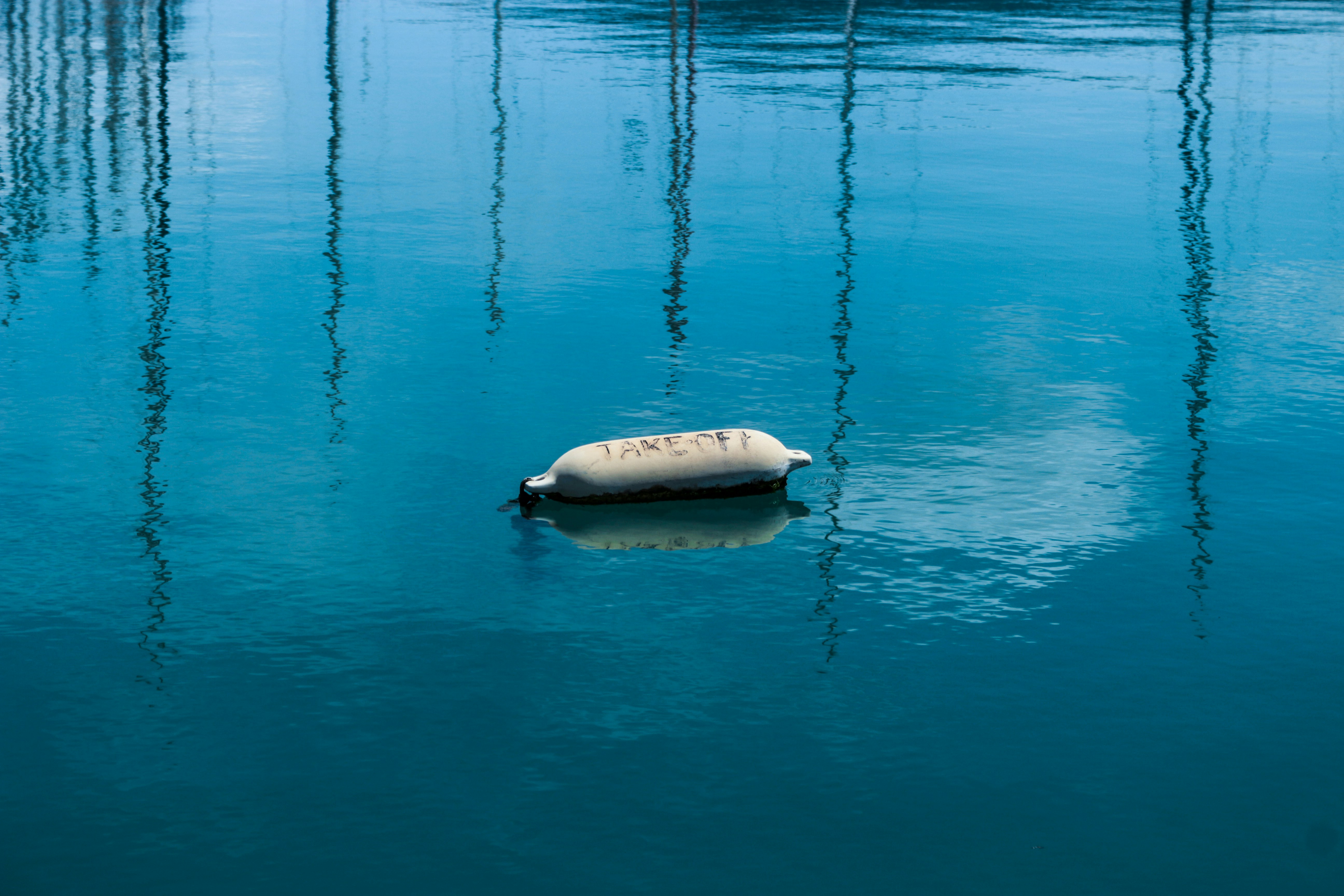 Boat Floats Quietly in a Mirror-like Harbor