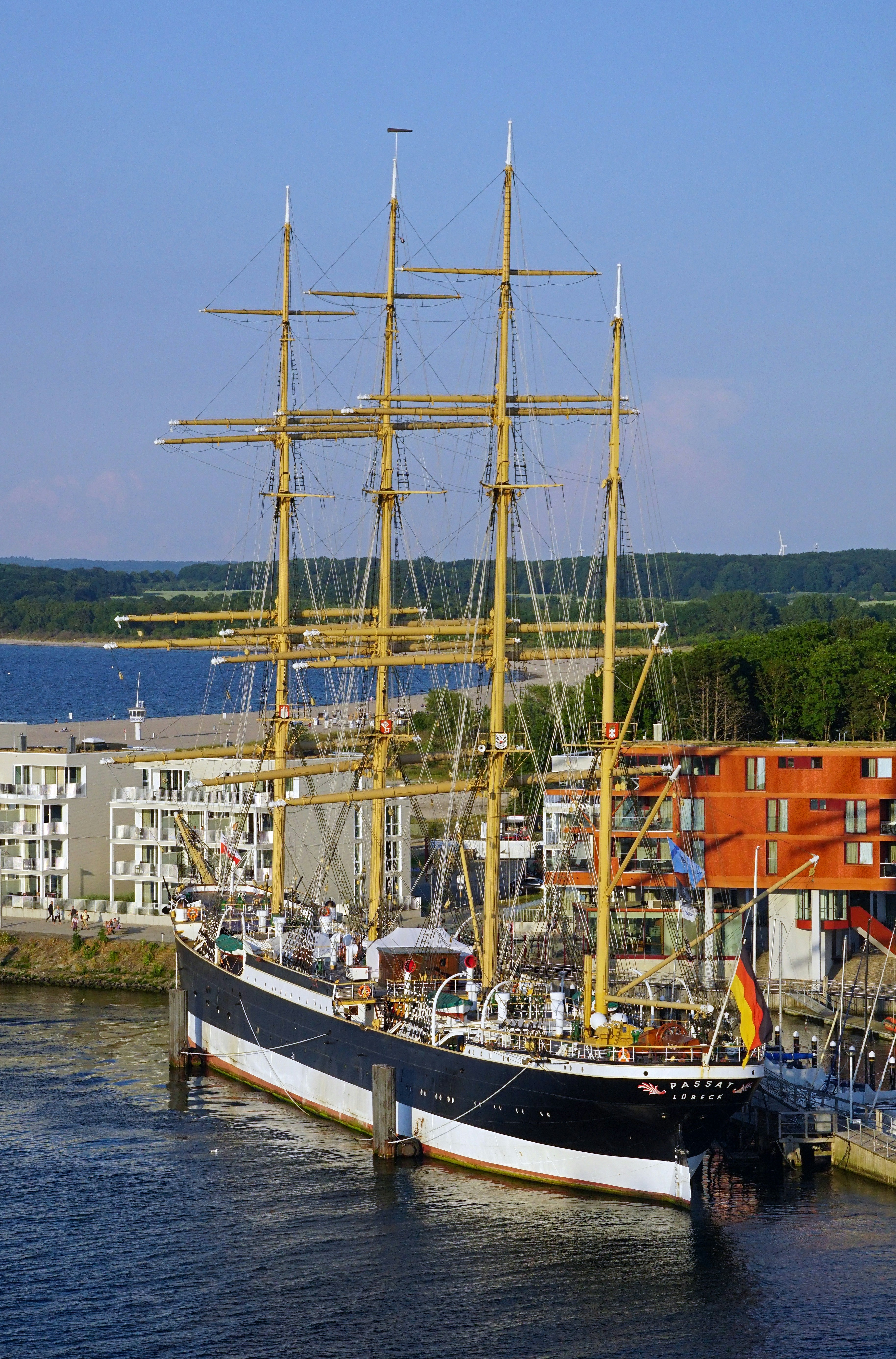 Sunlit Masts at the Quay: A Tall Ship Resting in the Port