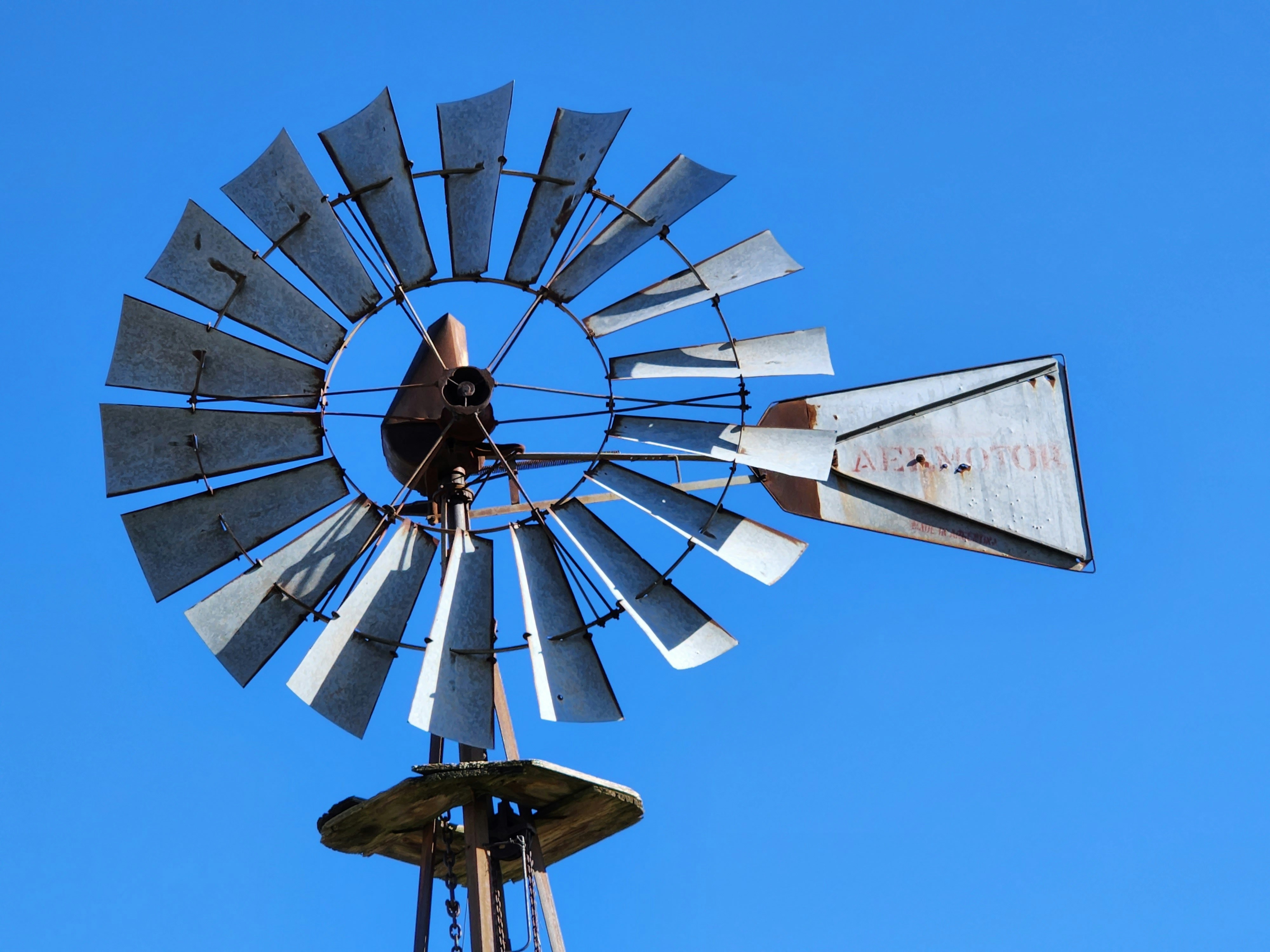 Center Hub of a Circular Windmill under a Clear Cerulean Sky